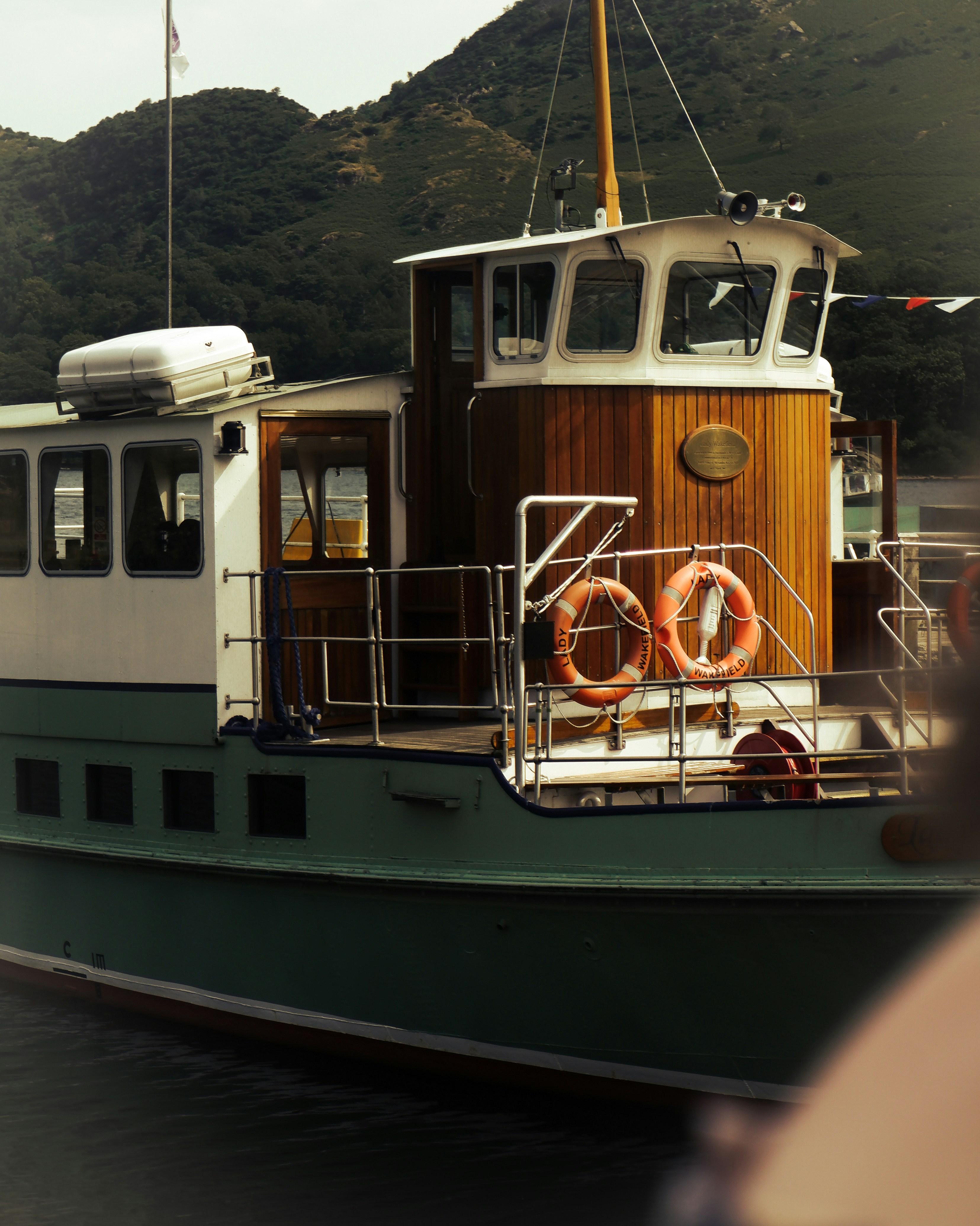 Wood and Water: A Vintage Boat Framed by Hills