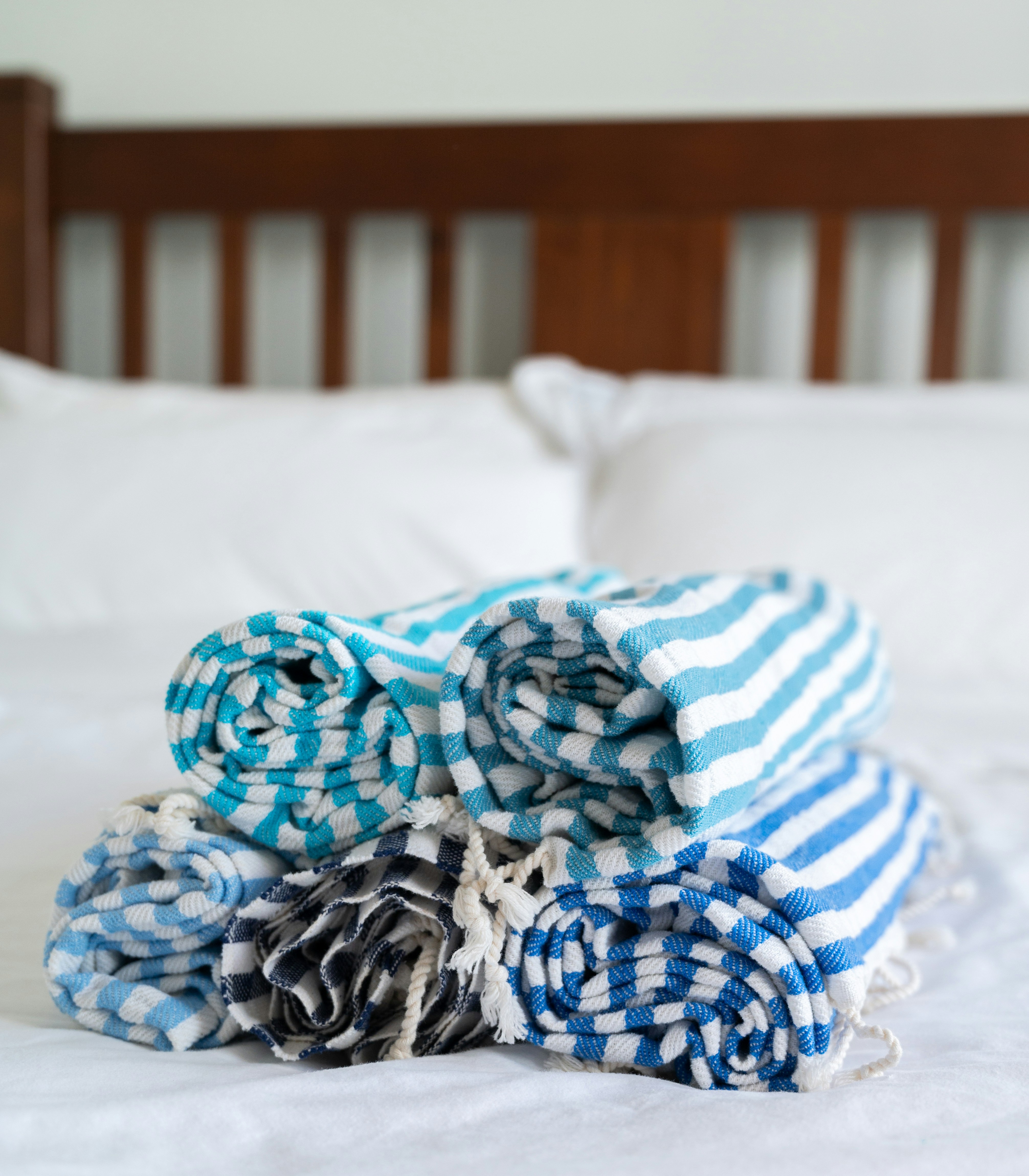 Shades Of Blue Striped Blankets On White Bed