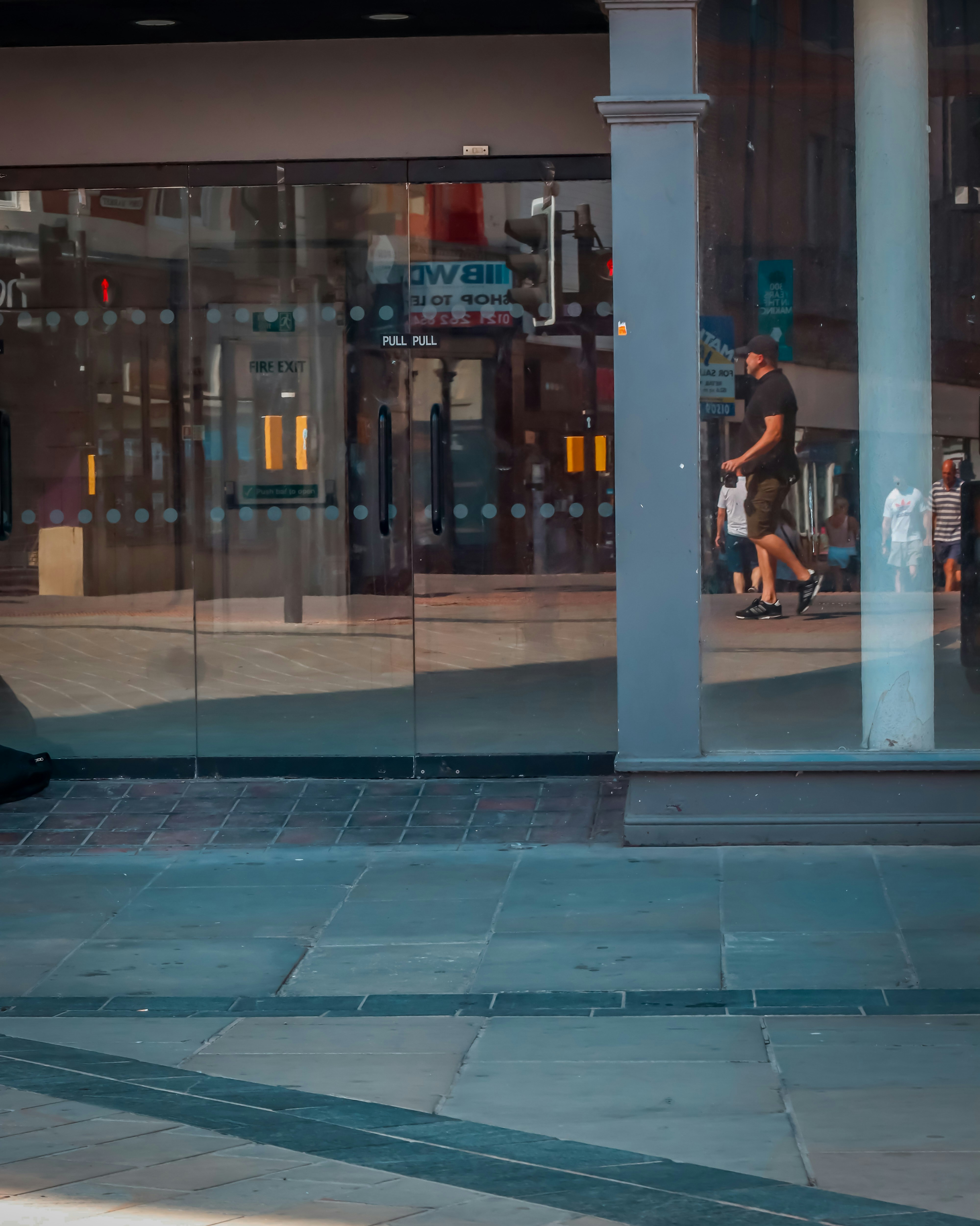 a person walking in front of a storefront