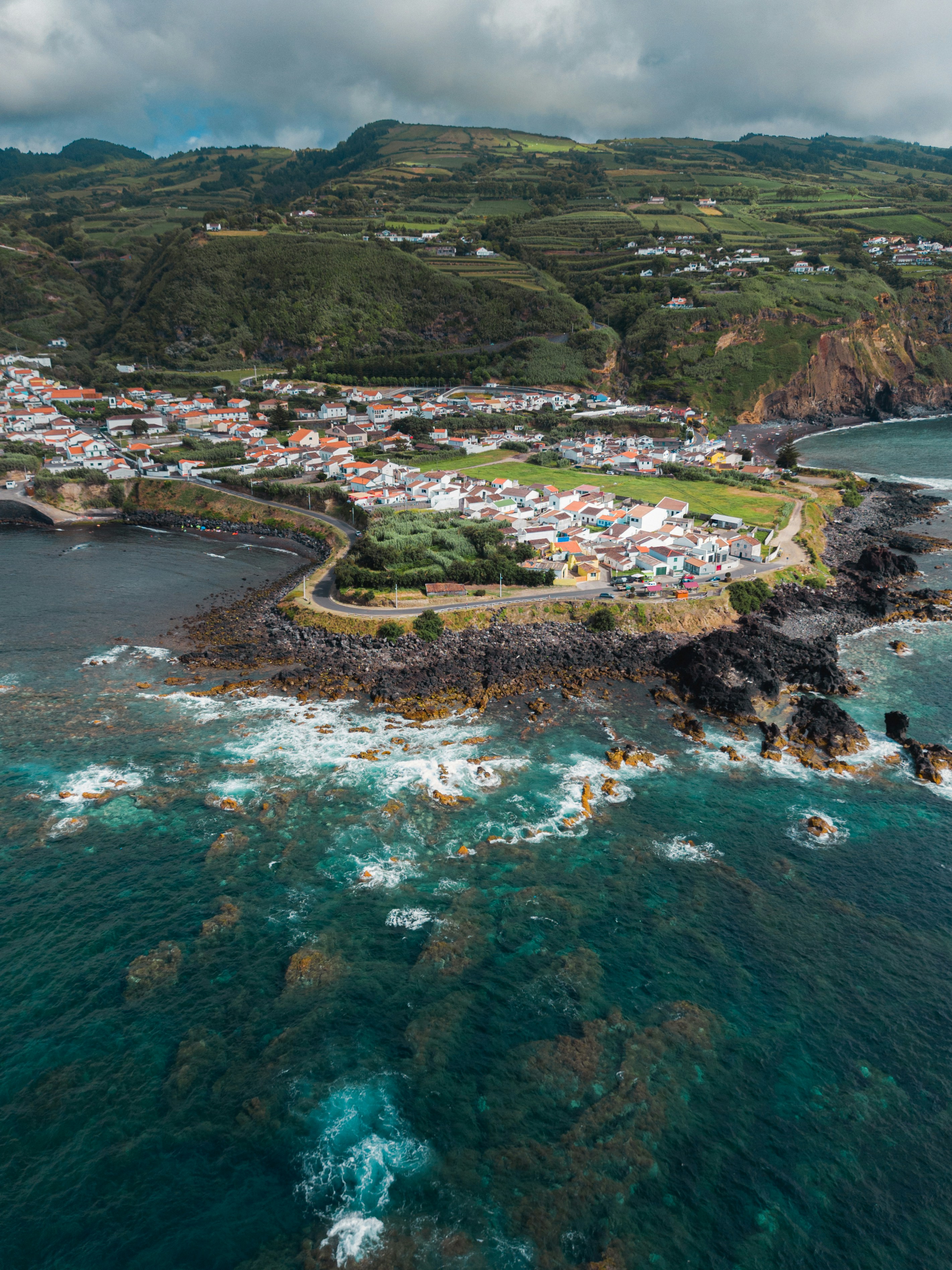 Verdant Cape Village at the Edge of Turquoise Seas