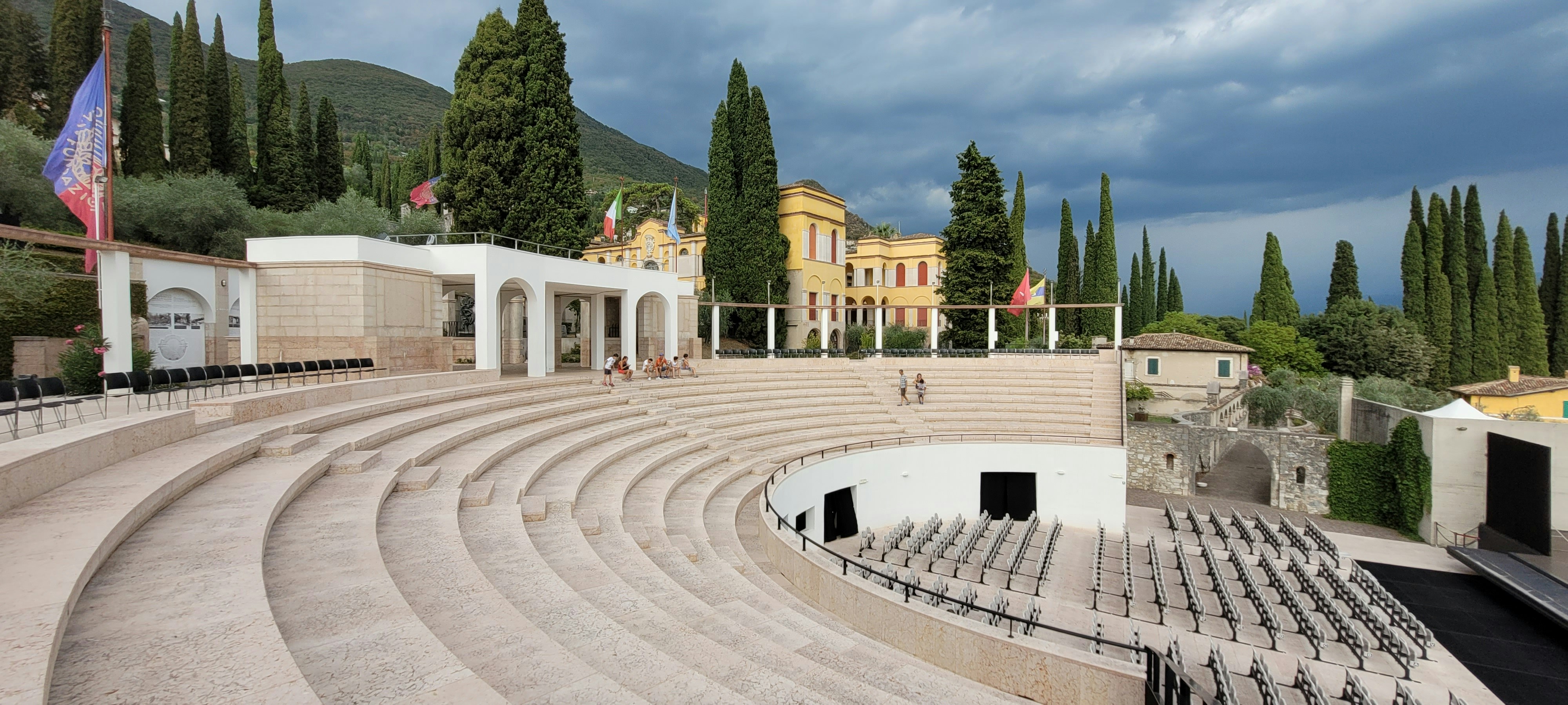 Stone Serpentine Auditorium Beneath a Cedar Skyline