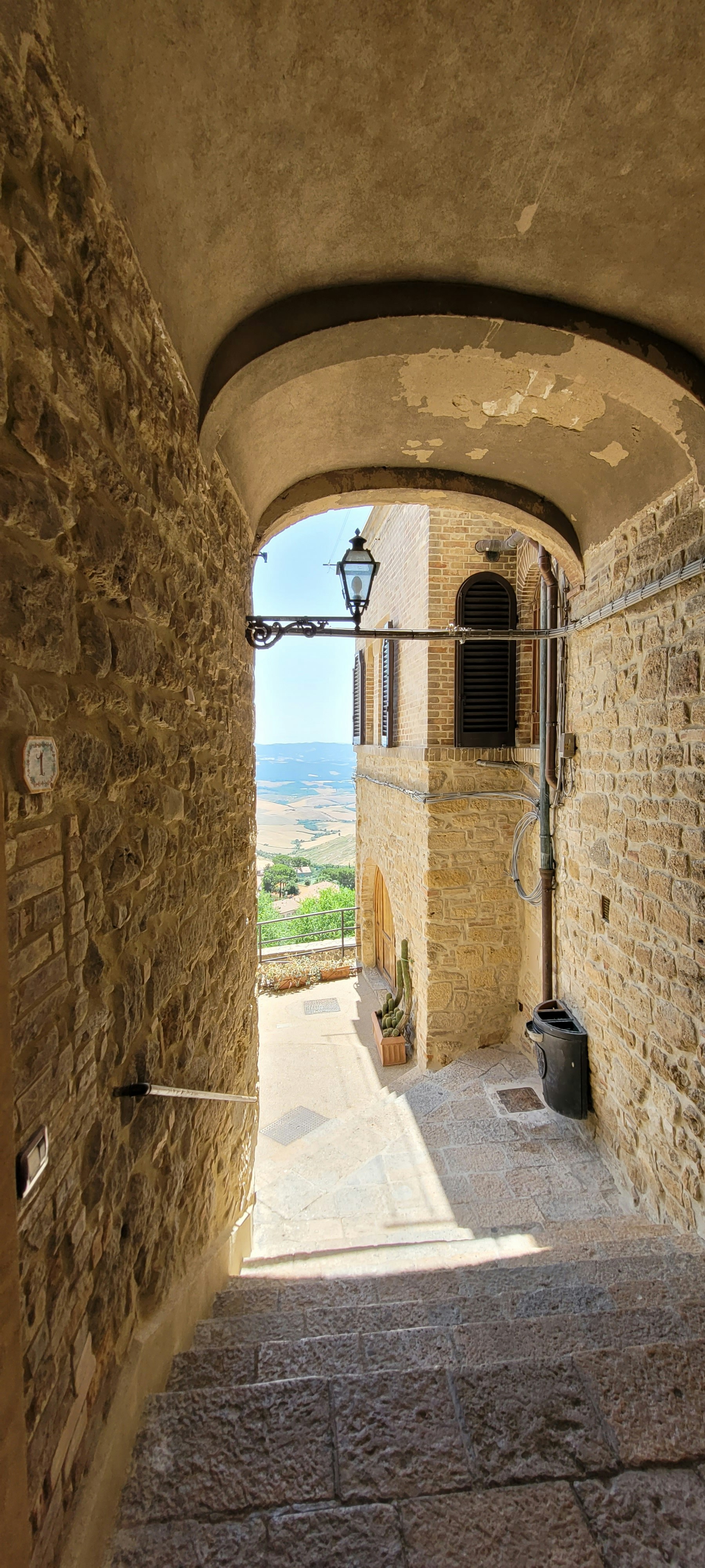 A stone walkway with a stone archway photo – Free Tuscany Image on Unsplash