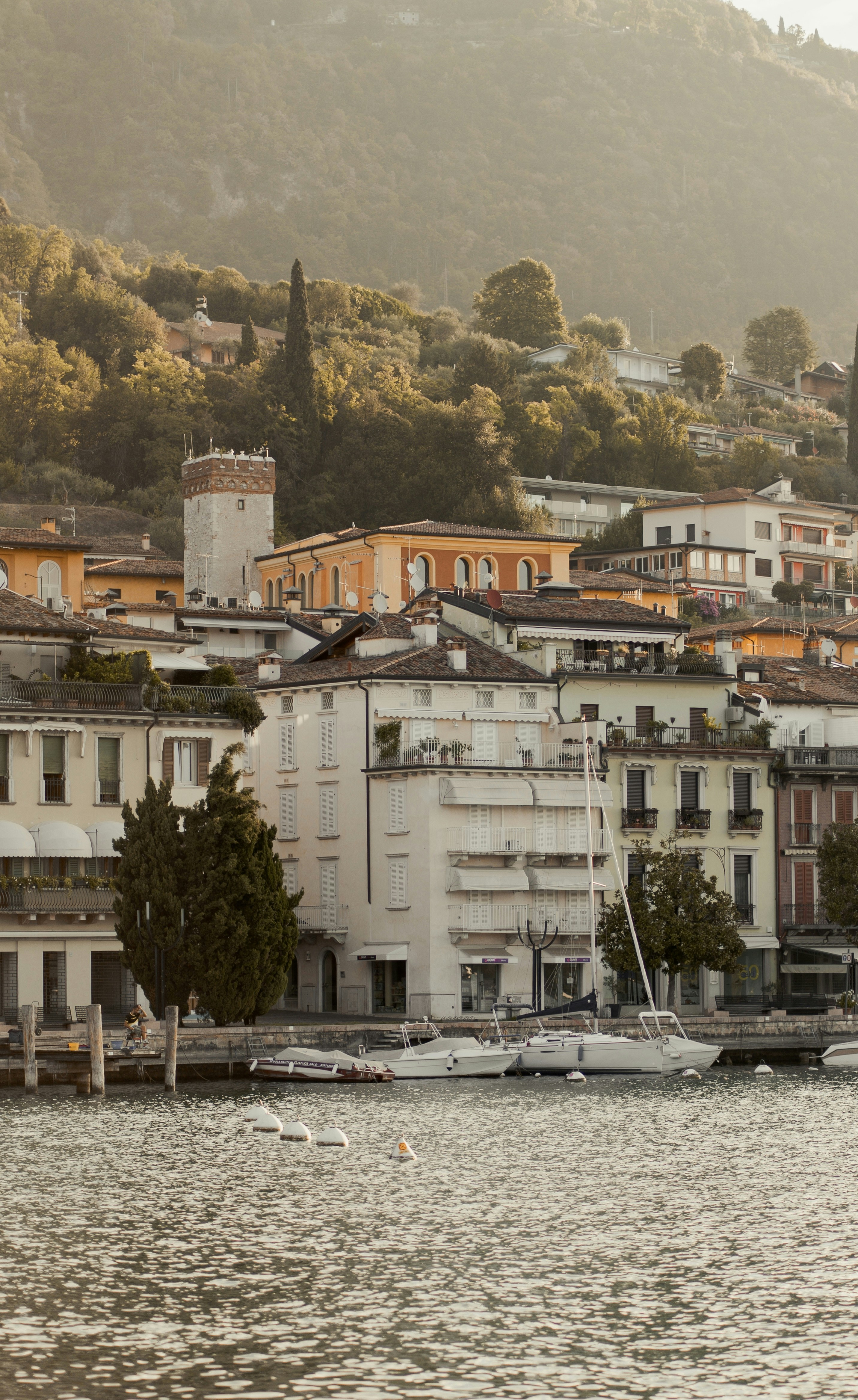 Sunlit Lakeside Village Emerging from the Hills