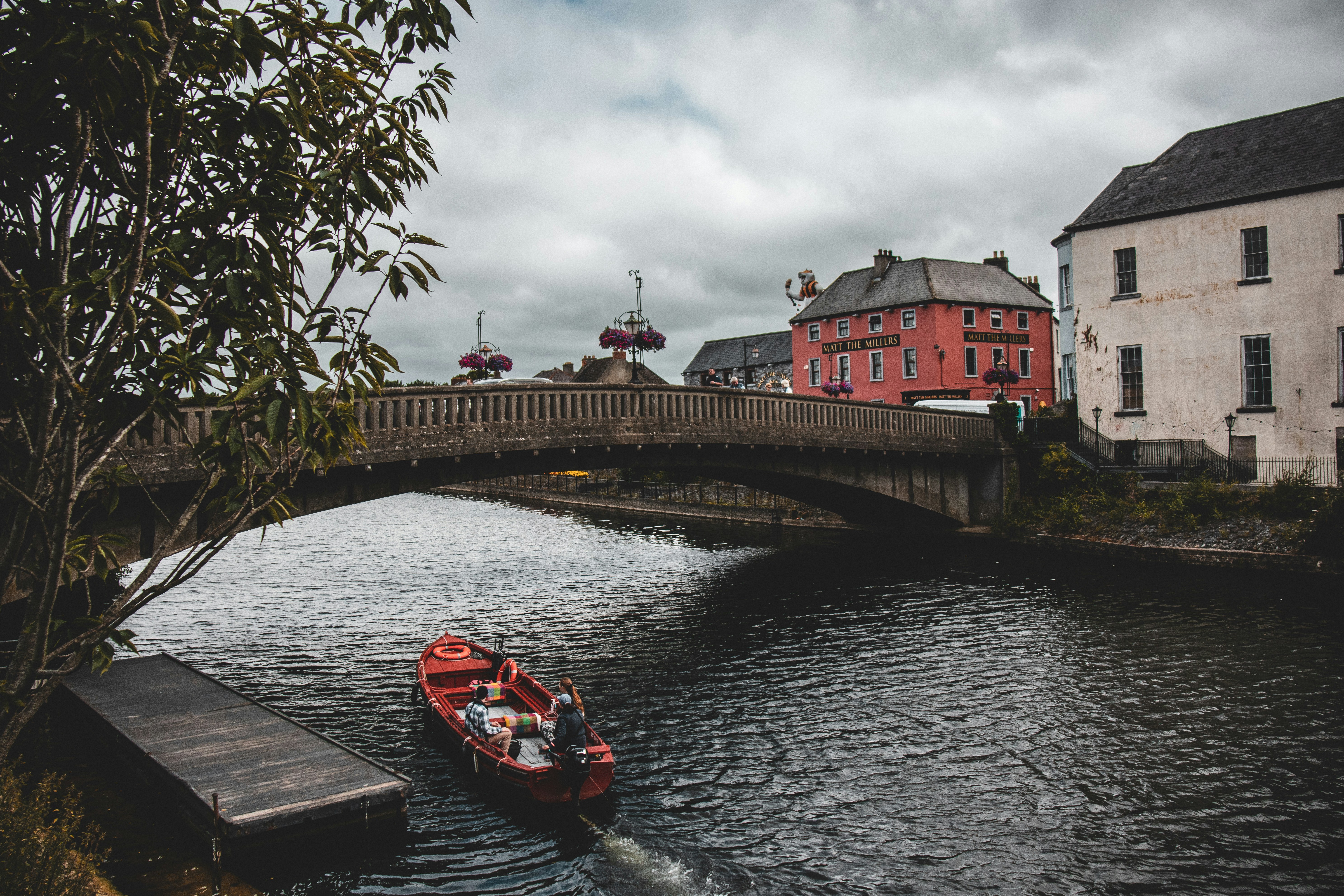a boat sailing under a bridge