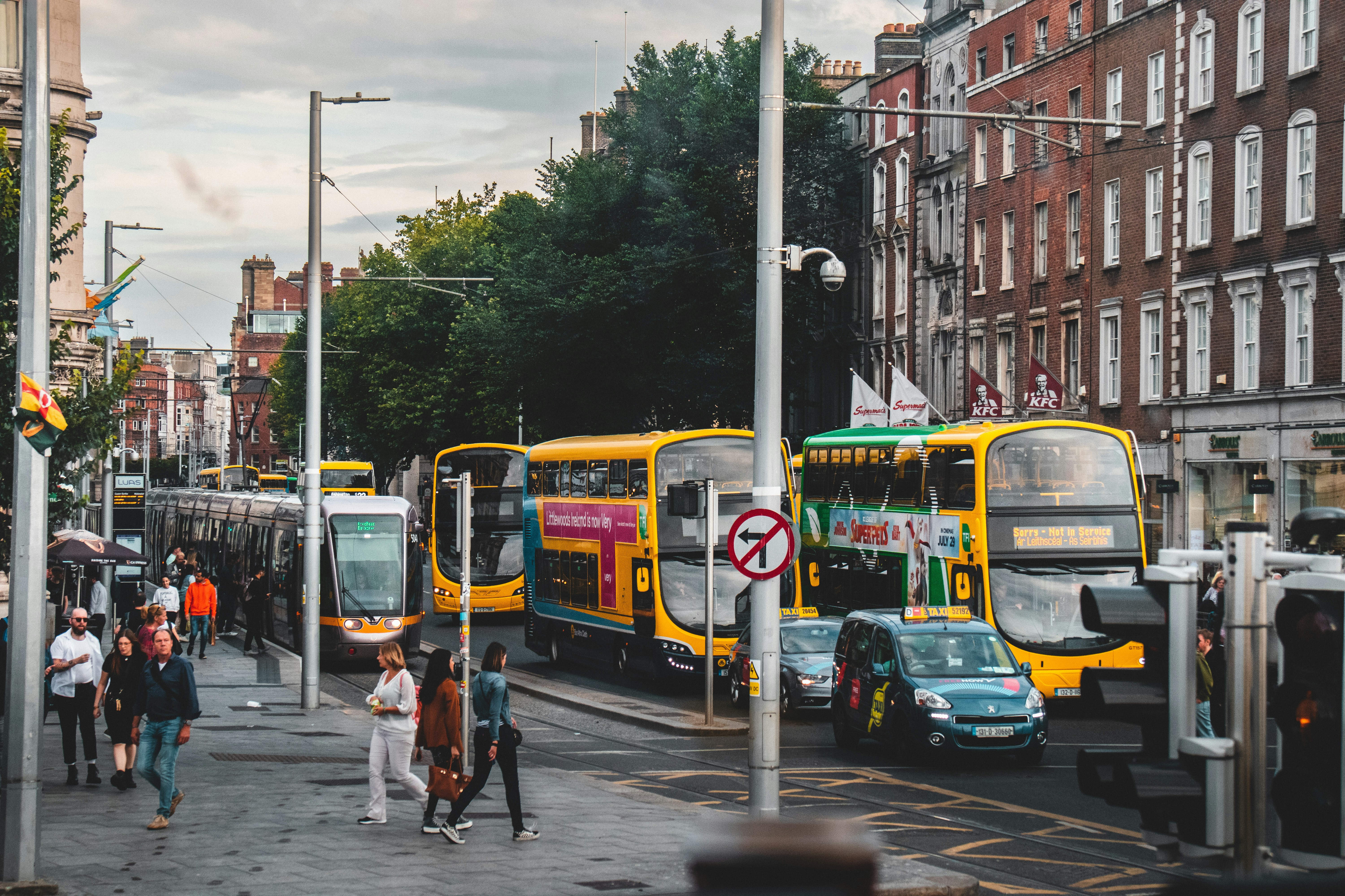 A group of buses and cars on a street photo – Free Kilkenny Image on ...