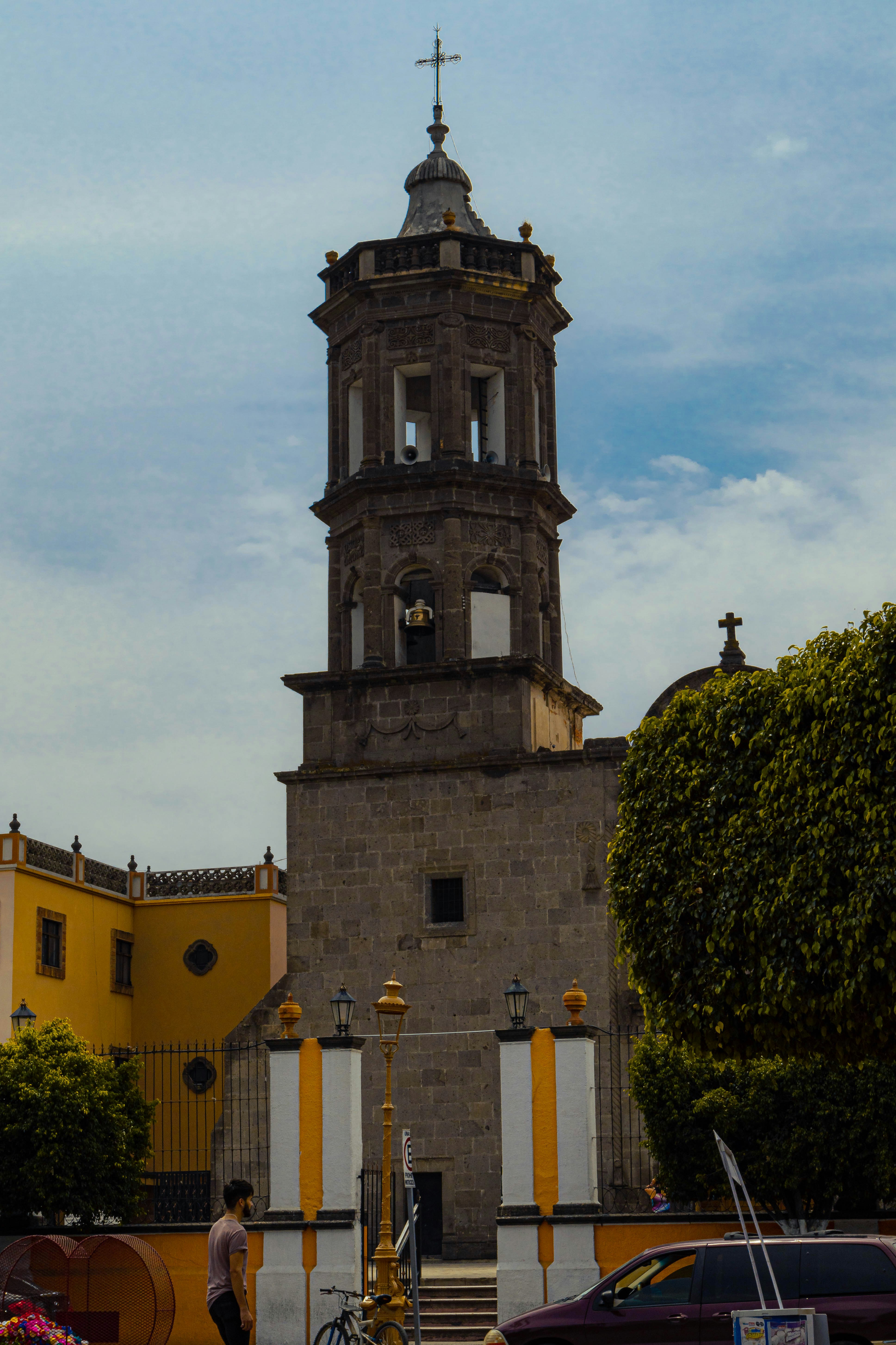 A tall building with a cross on top photo – Free Car Image on Unsplash