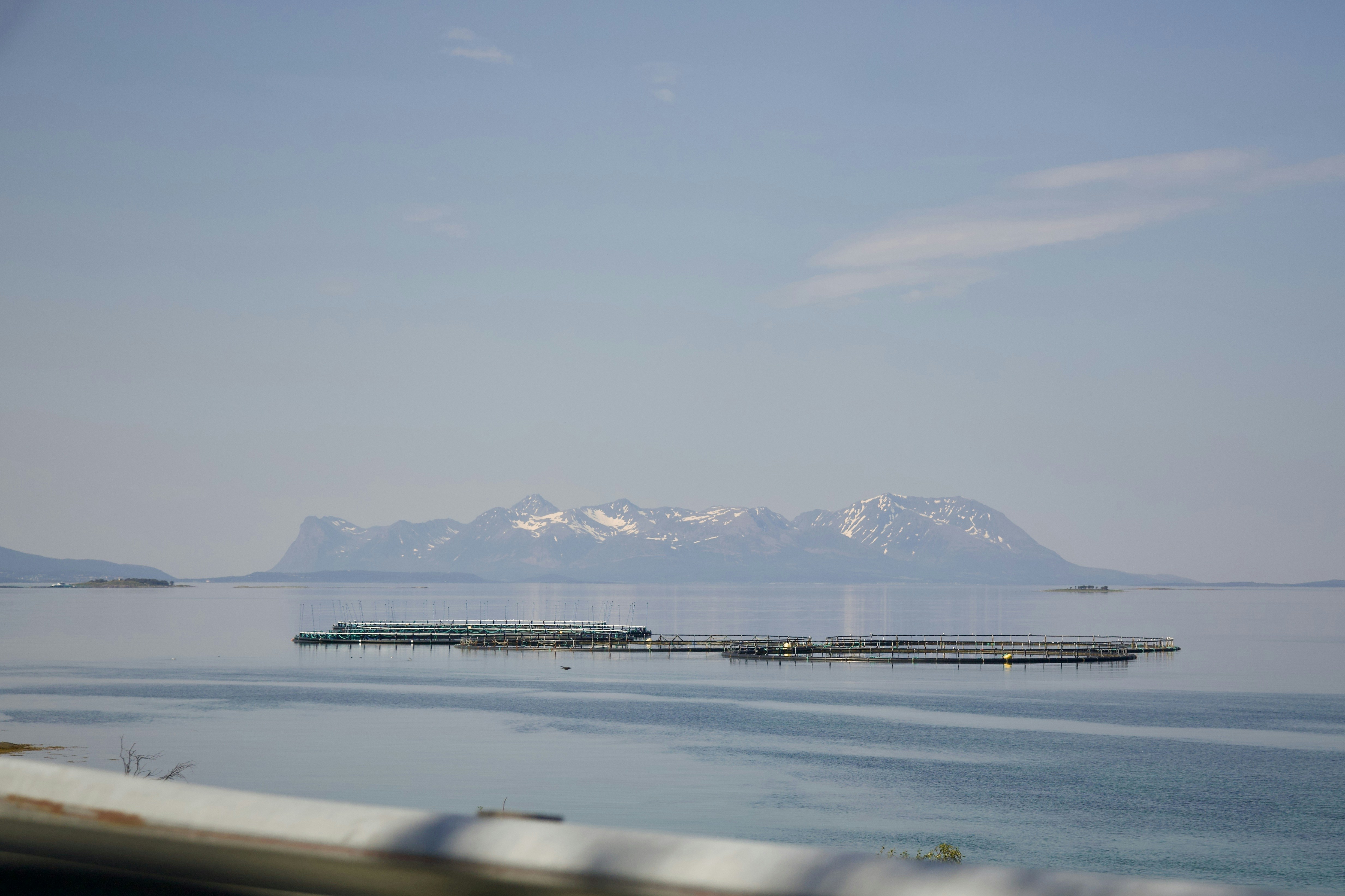 Glass-Fjord Quiet: Snow-Capped Peaks Reflected Over Floating Platforms