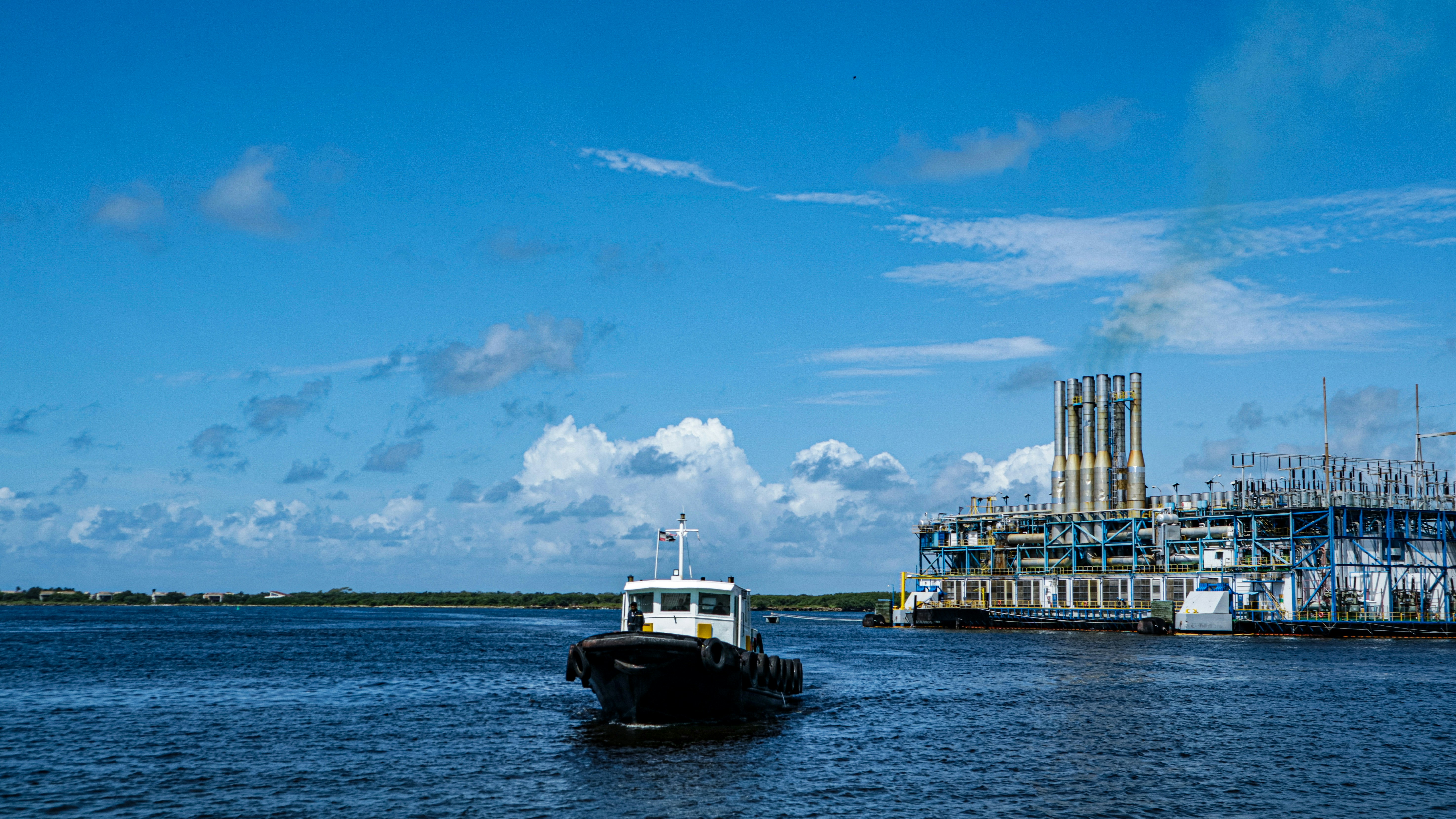 Thug boat's approaching under the blue sky