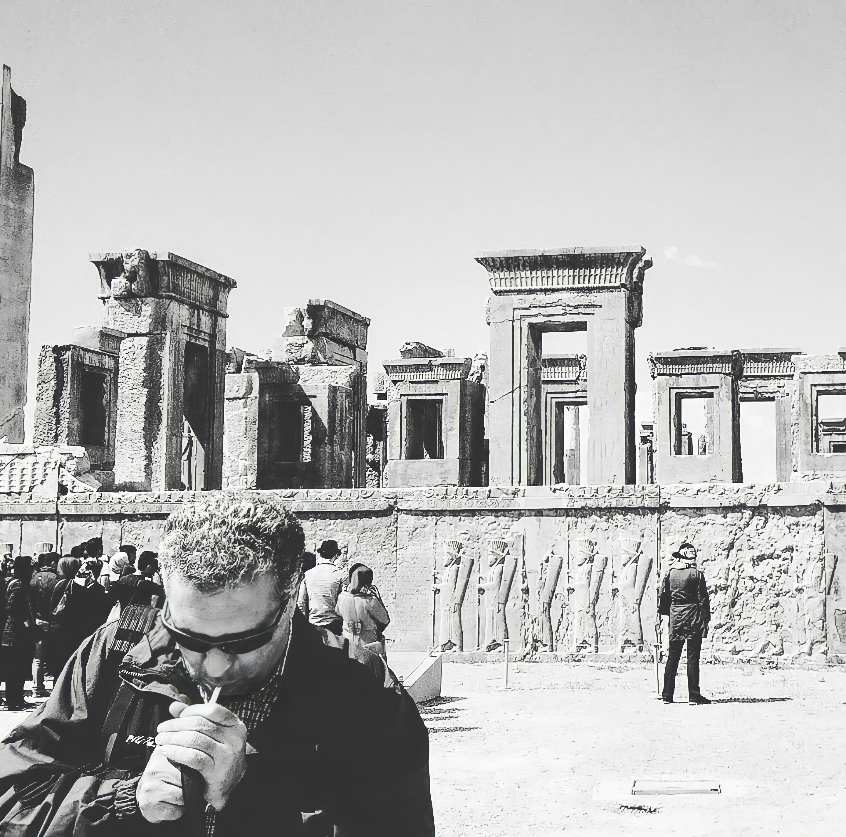 A person taking a picture of a building with many people in the ...