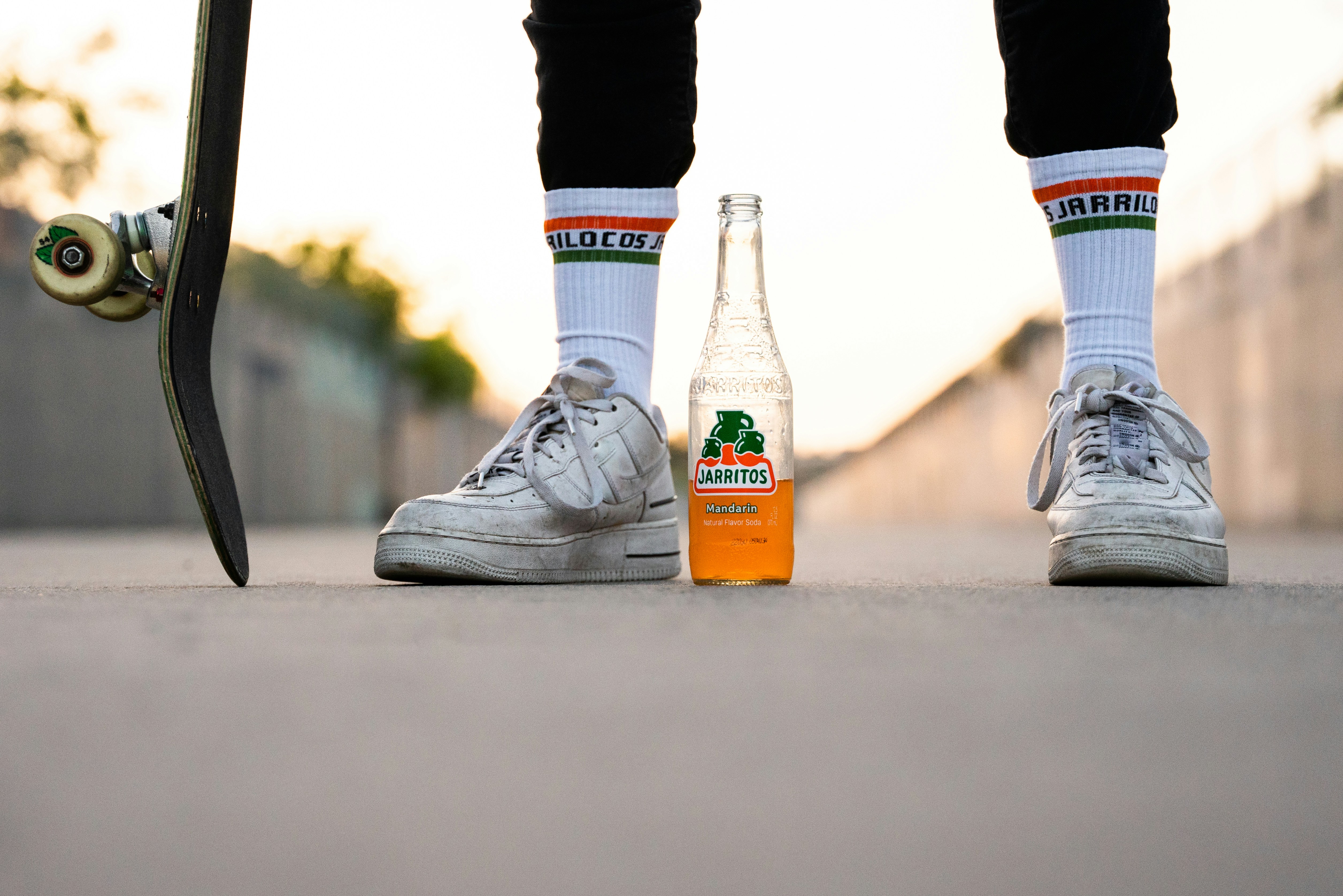 A person's legs and feet with a bottle of liquid photo – Free Human ...