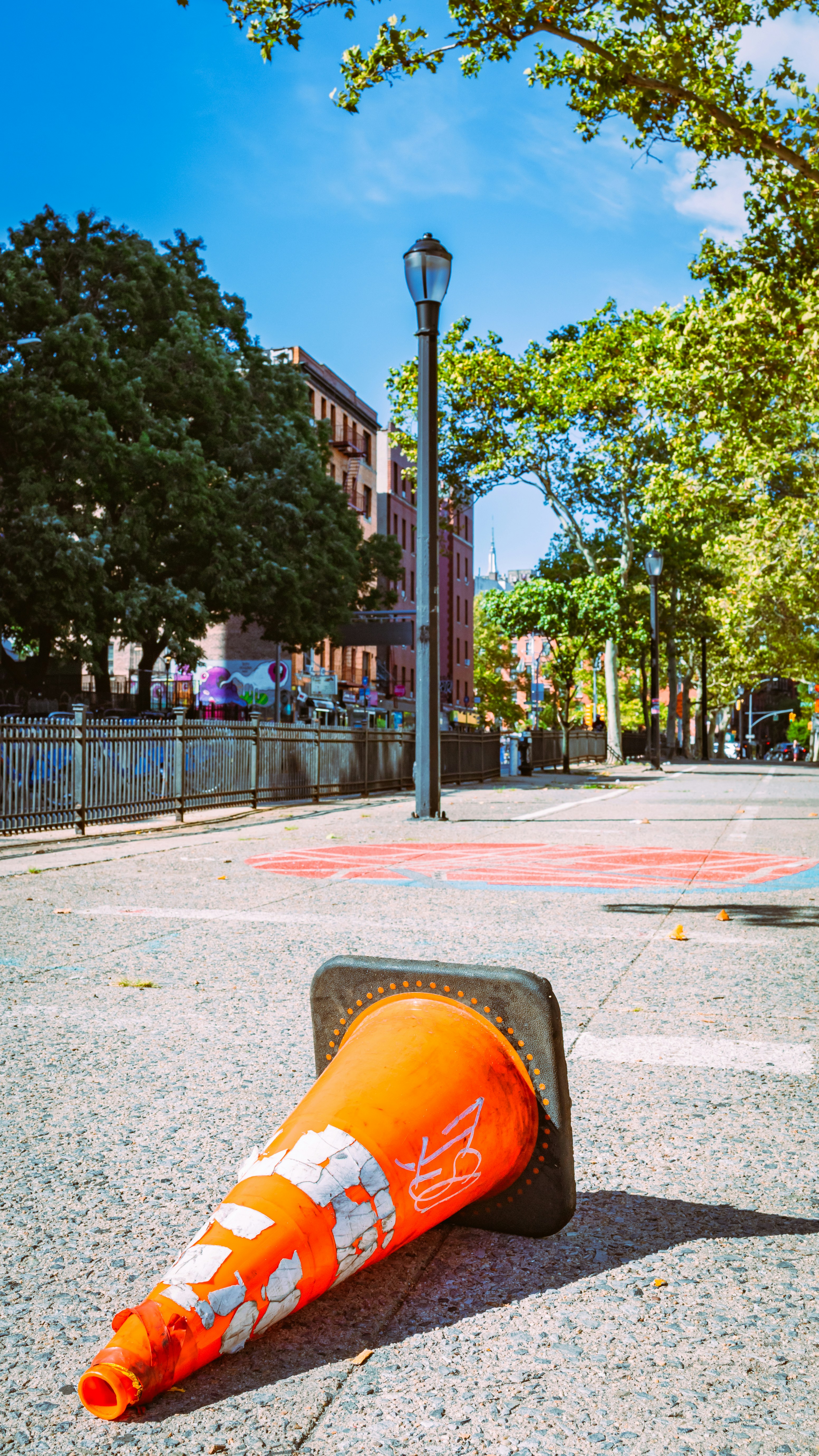 Orange Traffic Cone Reclaimed by Sunlit Street