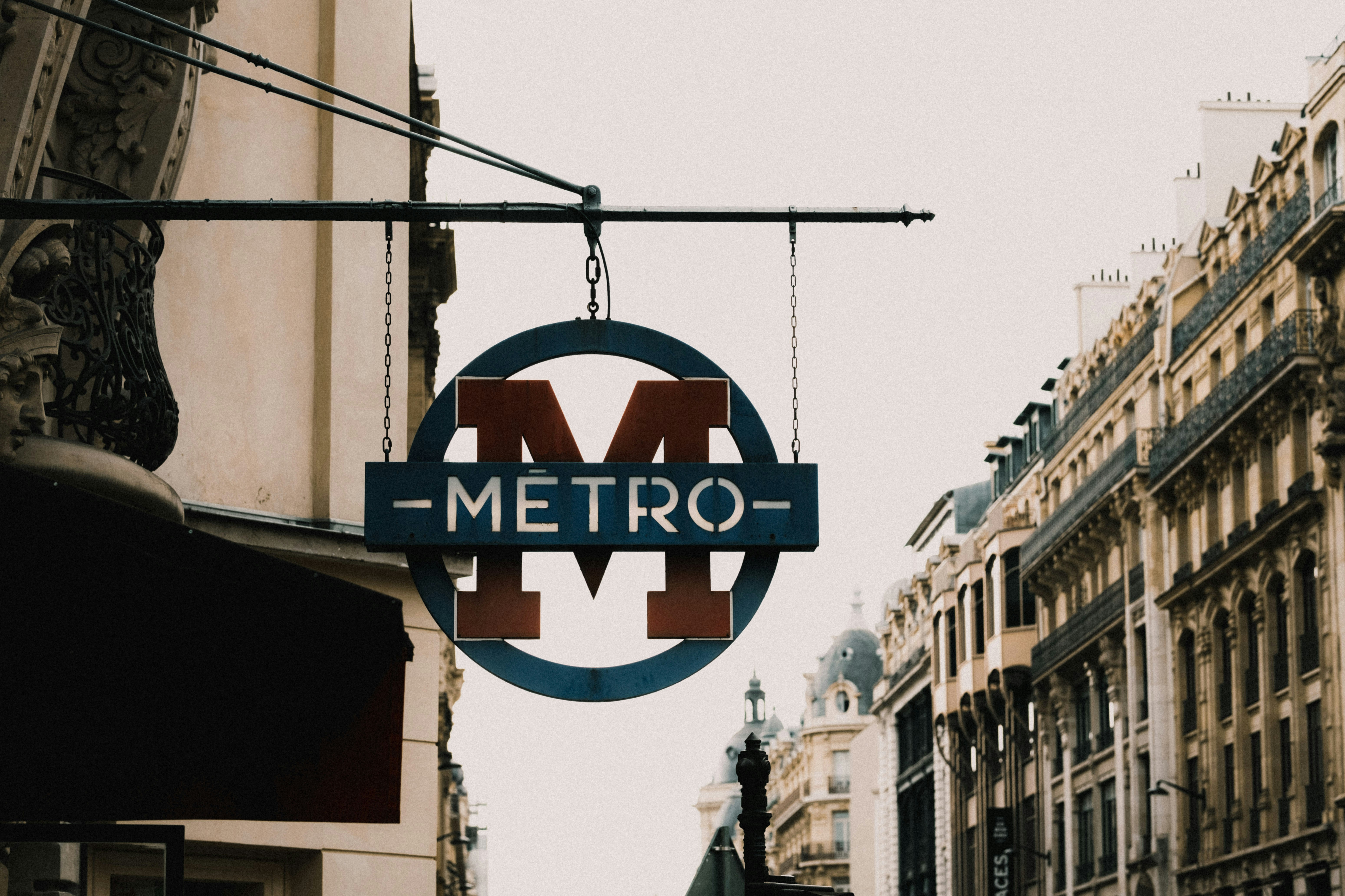 Circular Metro Emblem Framed by Parisian Facades