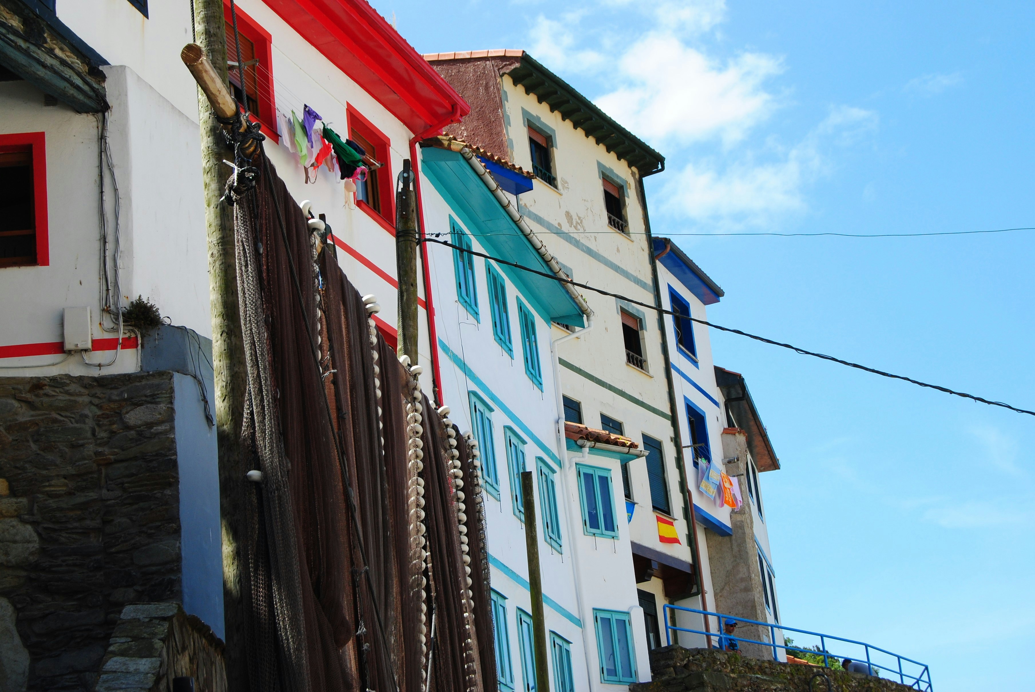 A row of buildings with blue and red rooftops photo – Free Building ...