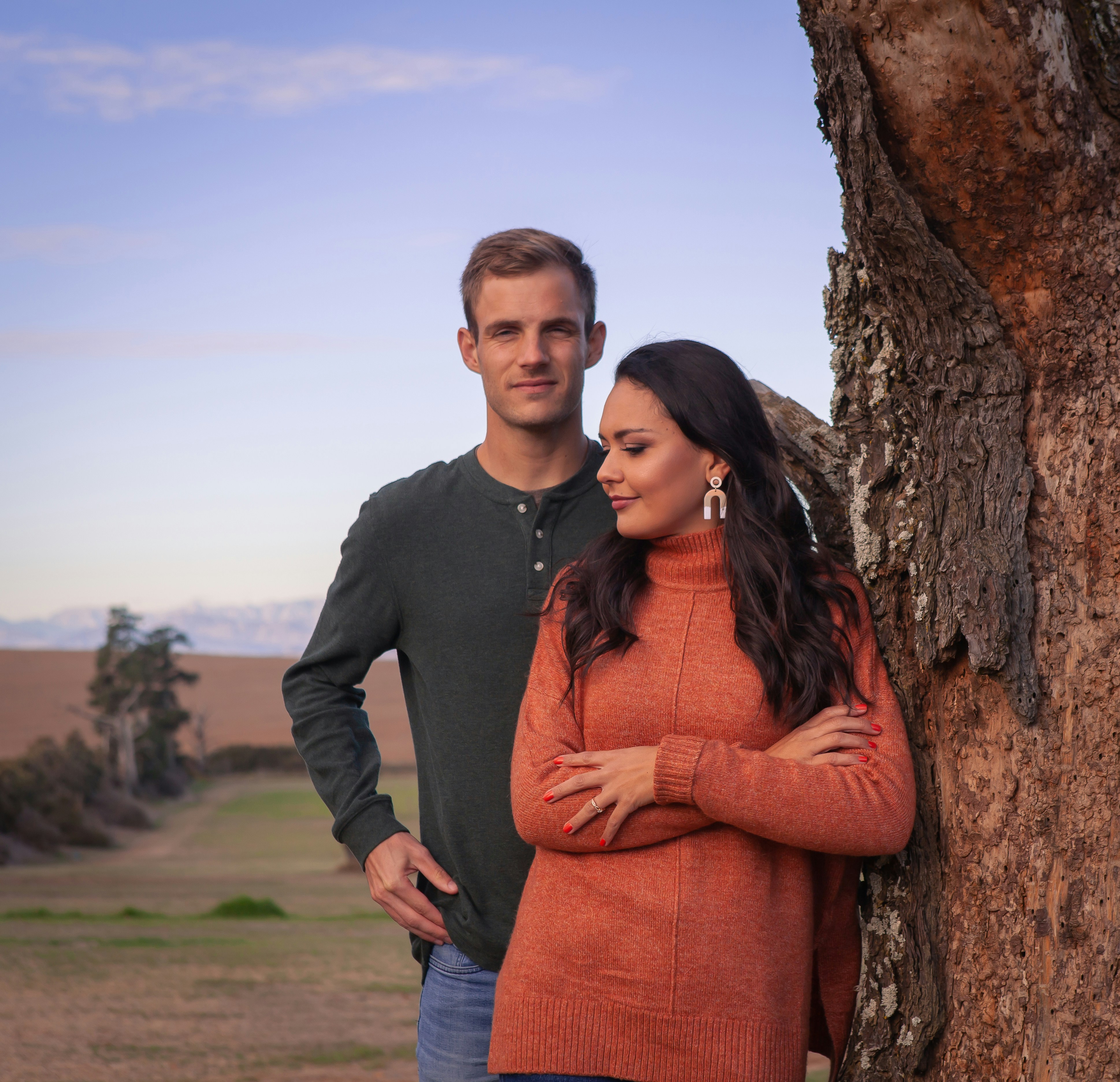 A man and woman standing next to a tree photo – Free Earing Image on ...