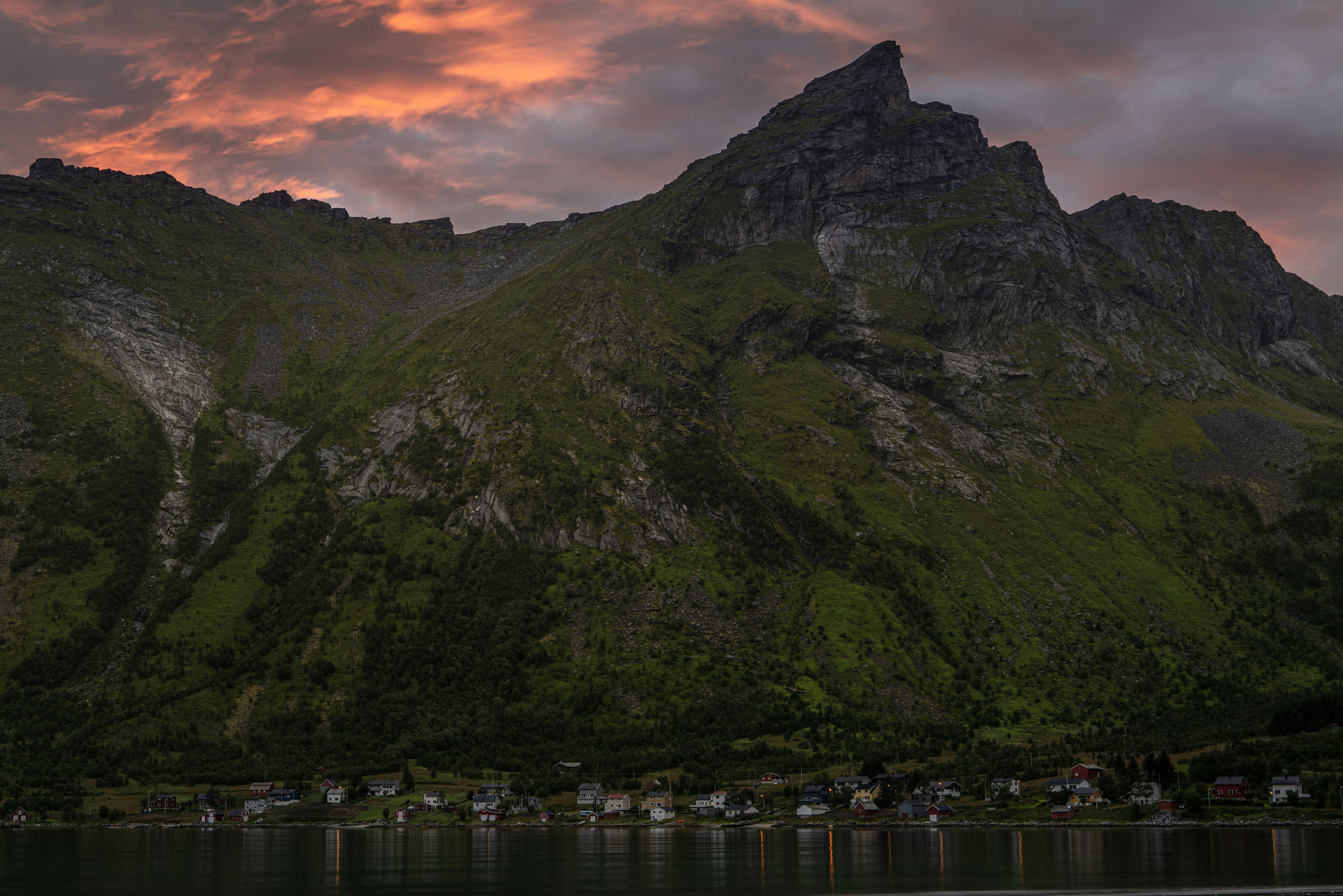 a body of water with boats and mountains in the background