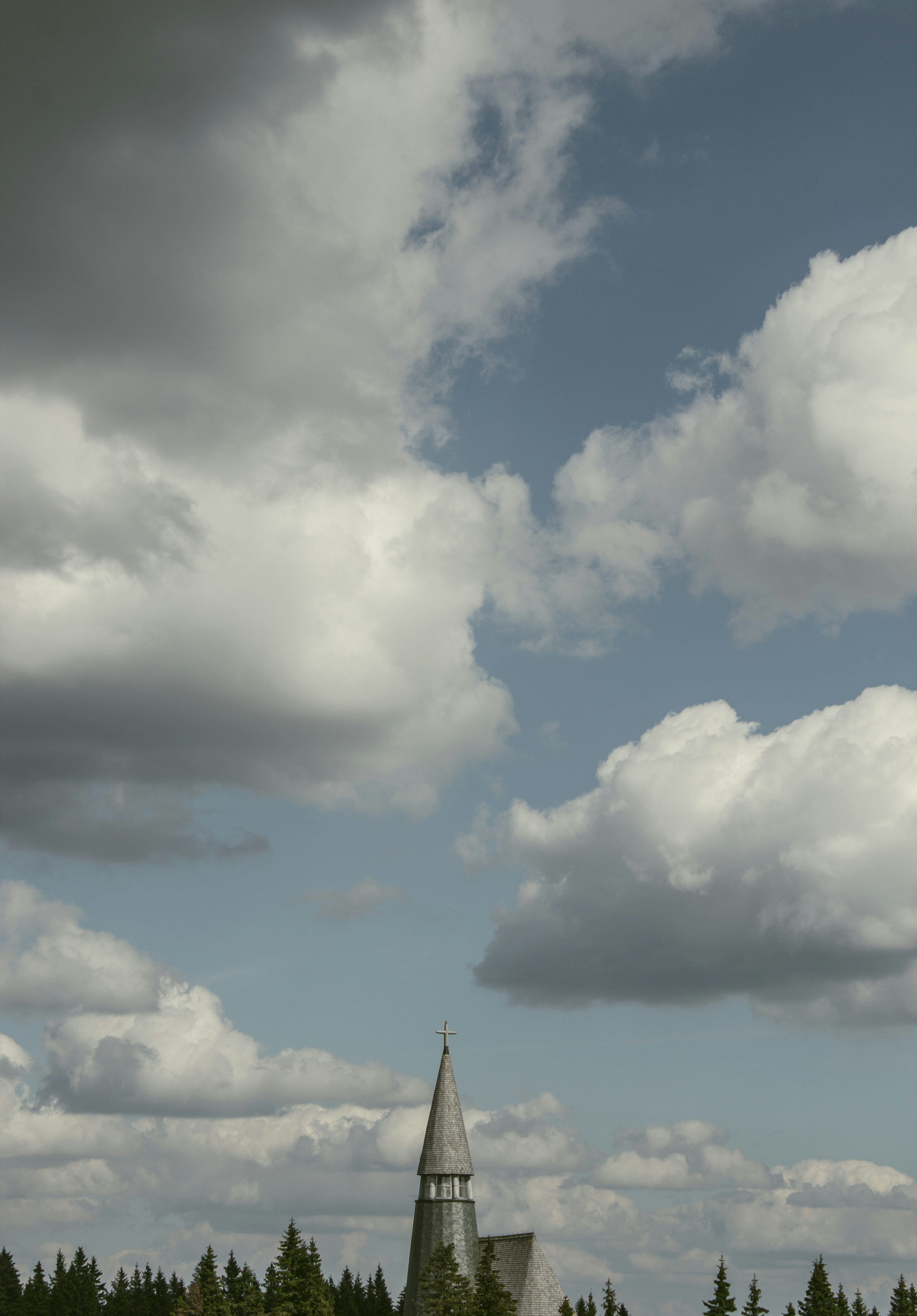 A tall tower with clouds above it photo – Free Rogla Image on Unsplash