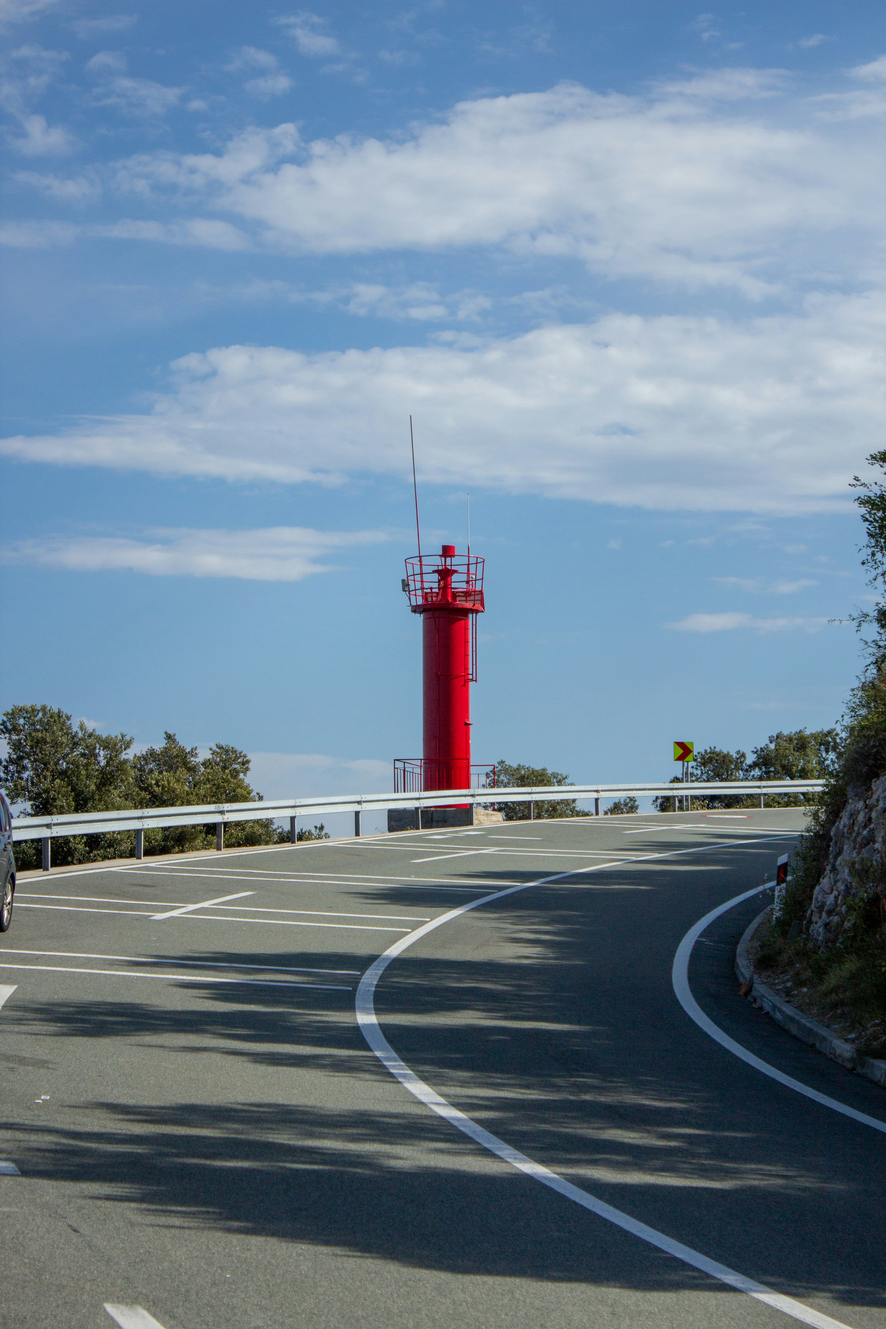 Crimson Beacon on the Winding Coastal Road