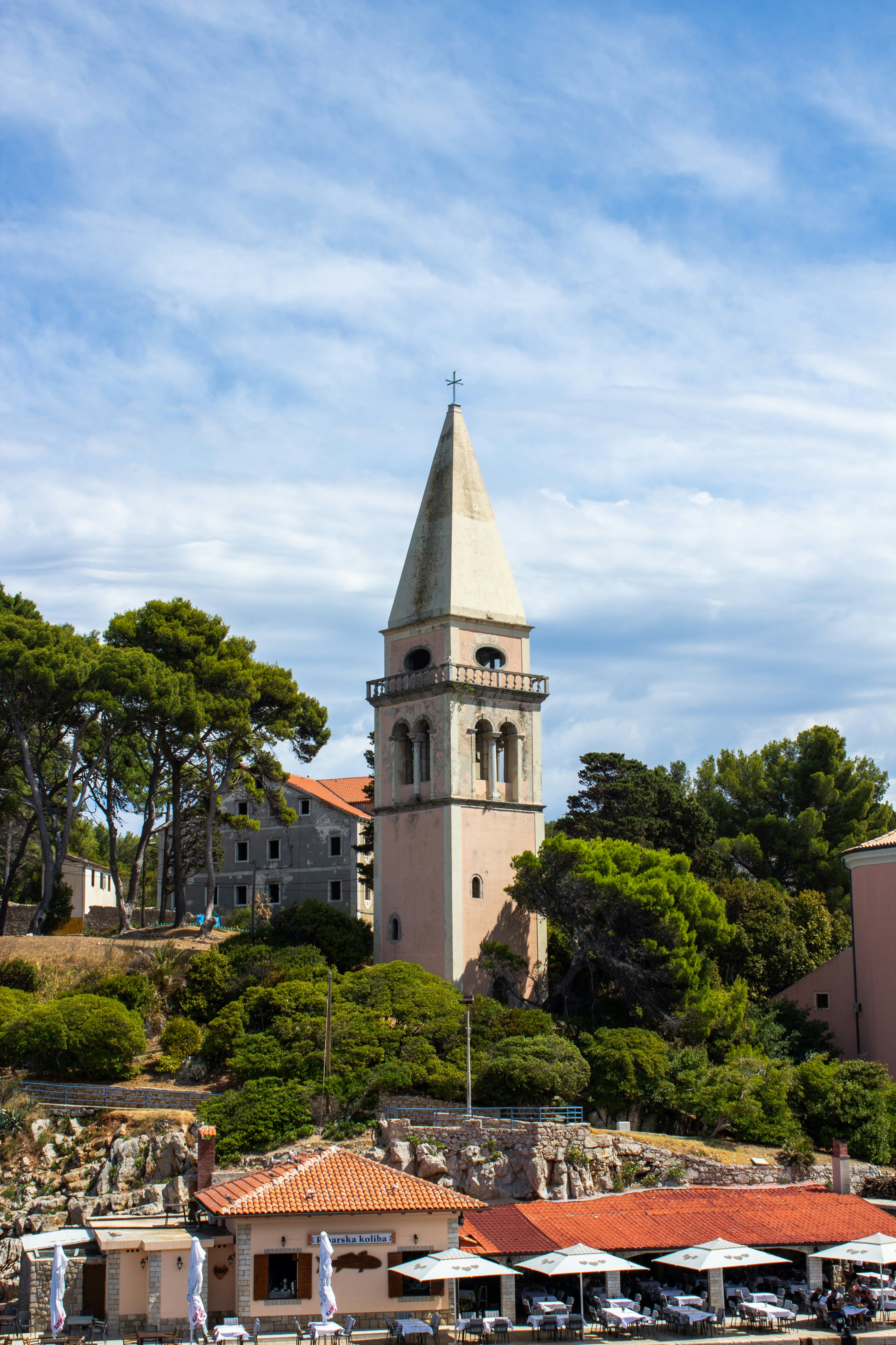 Pastel Bell Tower Framing a Sunlit Mediterranean Terrace