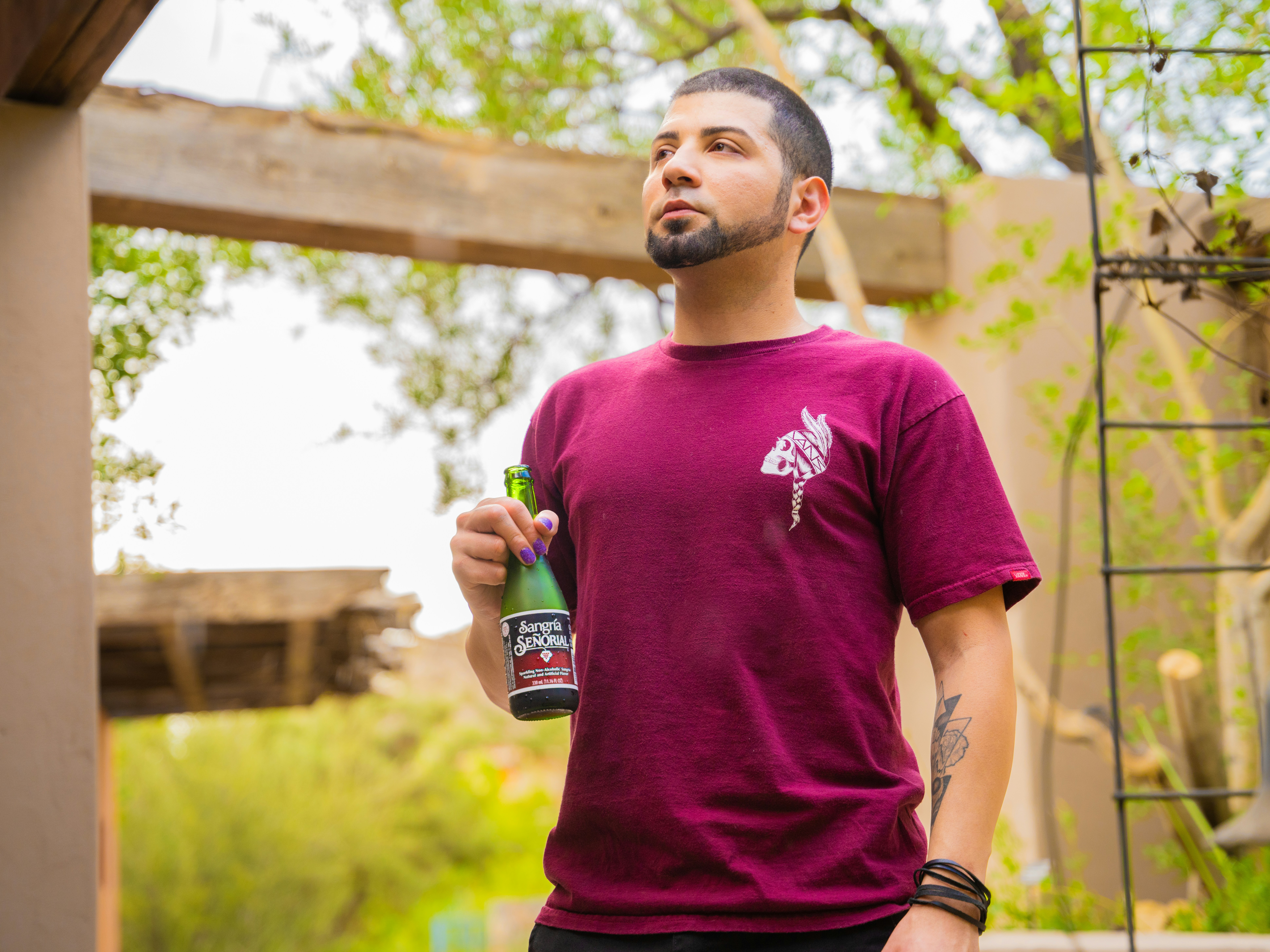 Bearded Portrait with a Bottle: Calm Confidence in a Backyard Setting