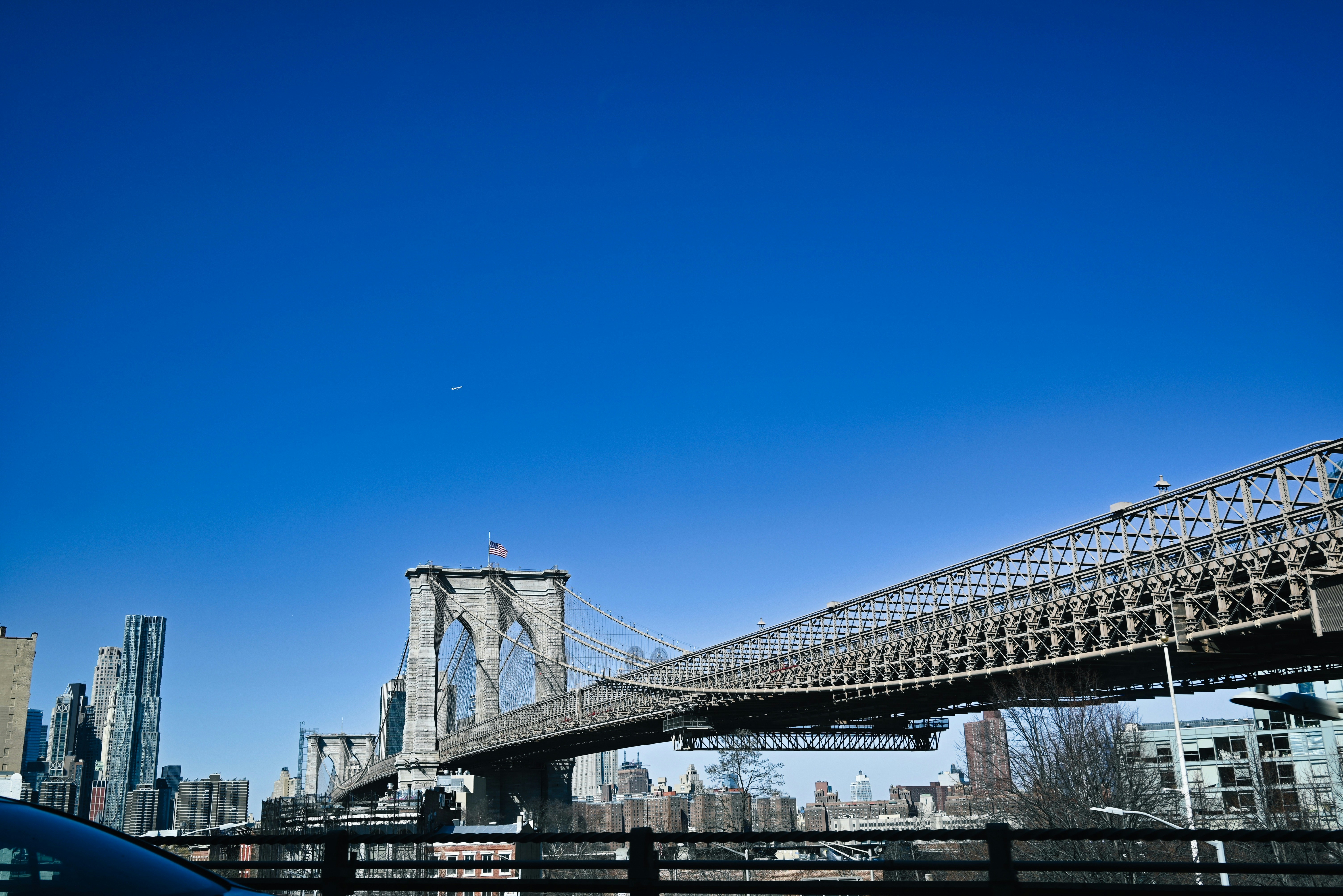 A bridge with a city in the background photo – Free Blue Image on Unsplash