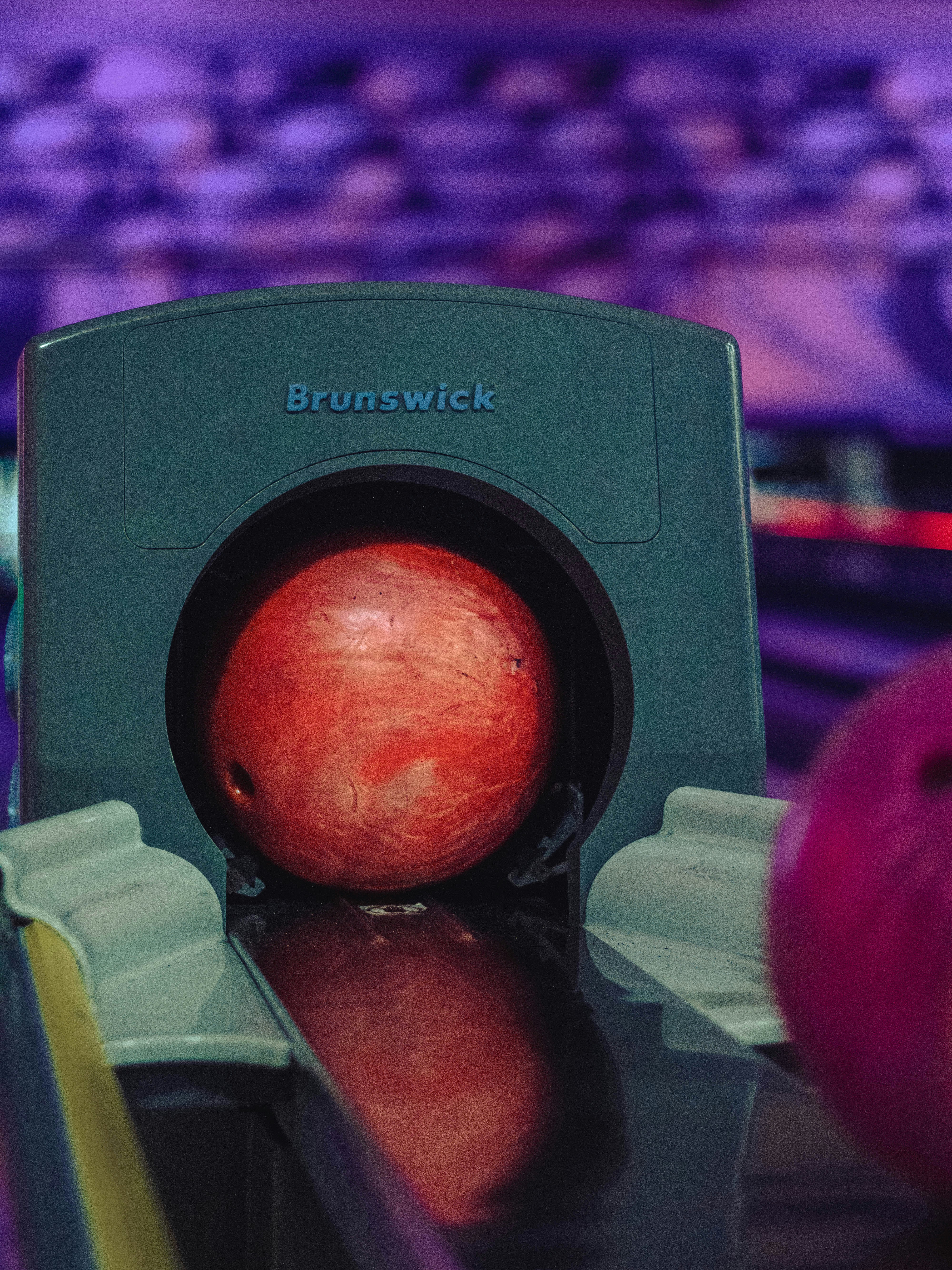 Red Orb in a Teal Brunswick Glow: A Neon Bowling Moment