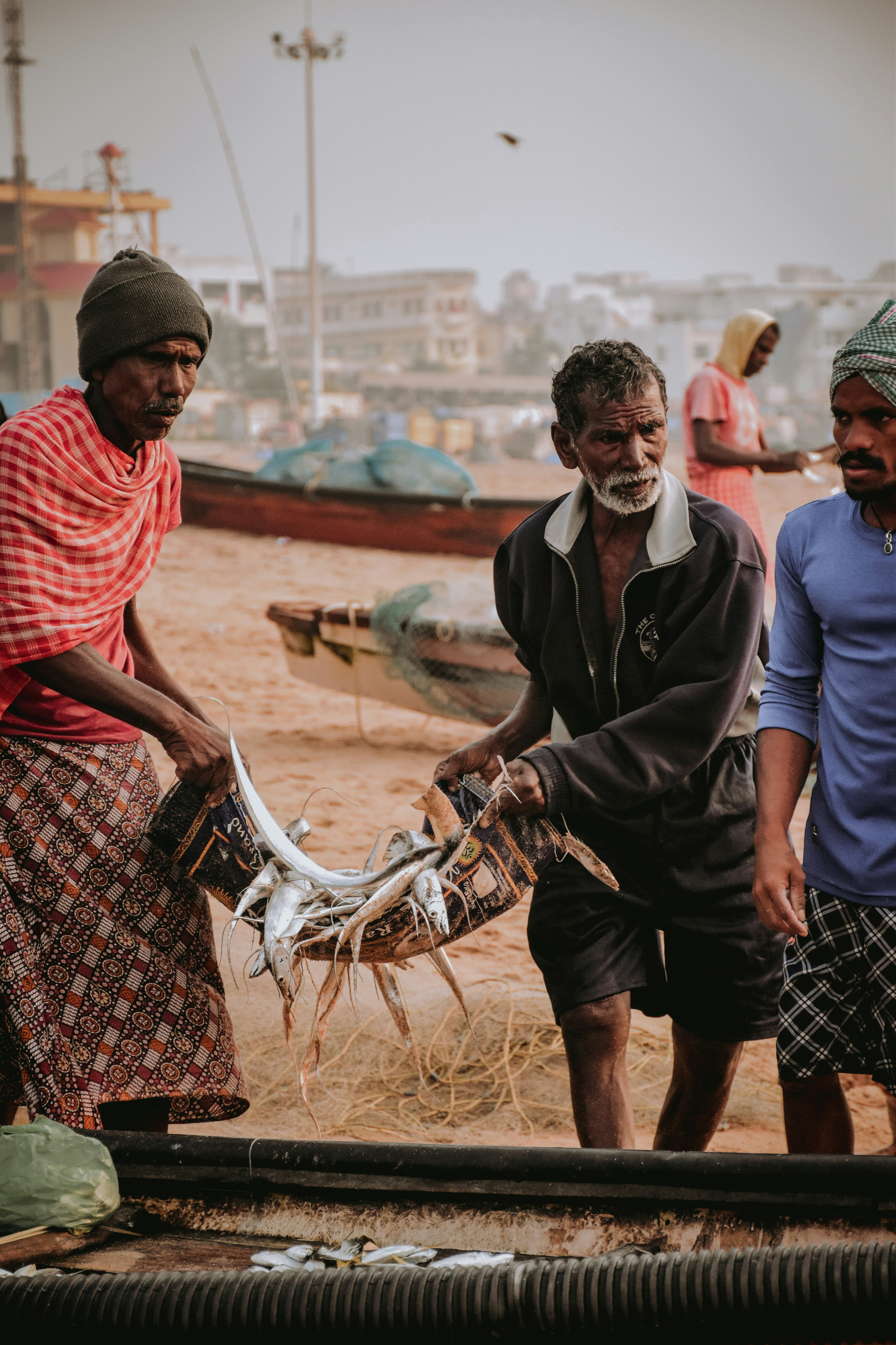a group of people standing next to a fishing net