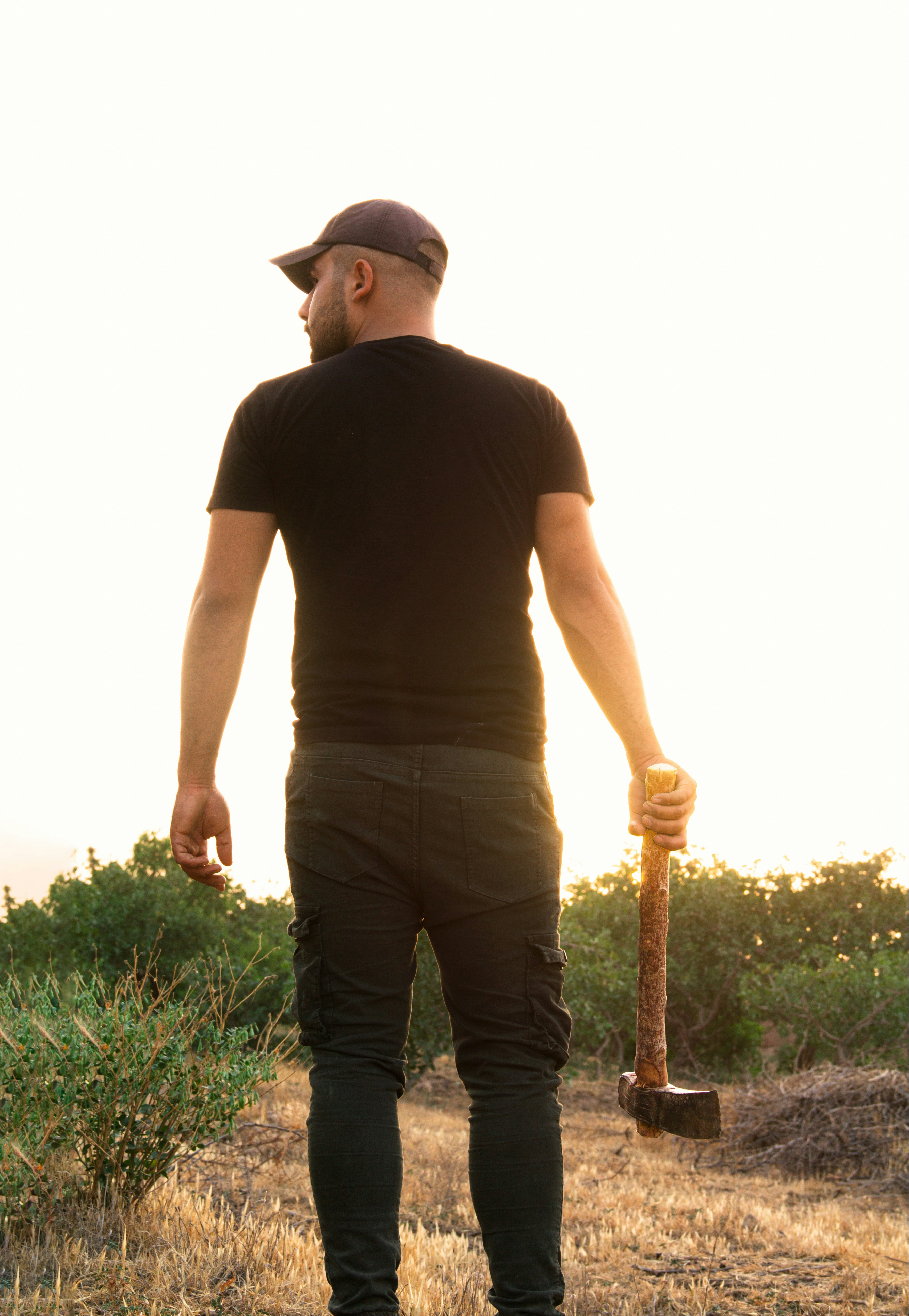 The Silent Blade: Man with Axe Under Open Sky