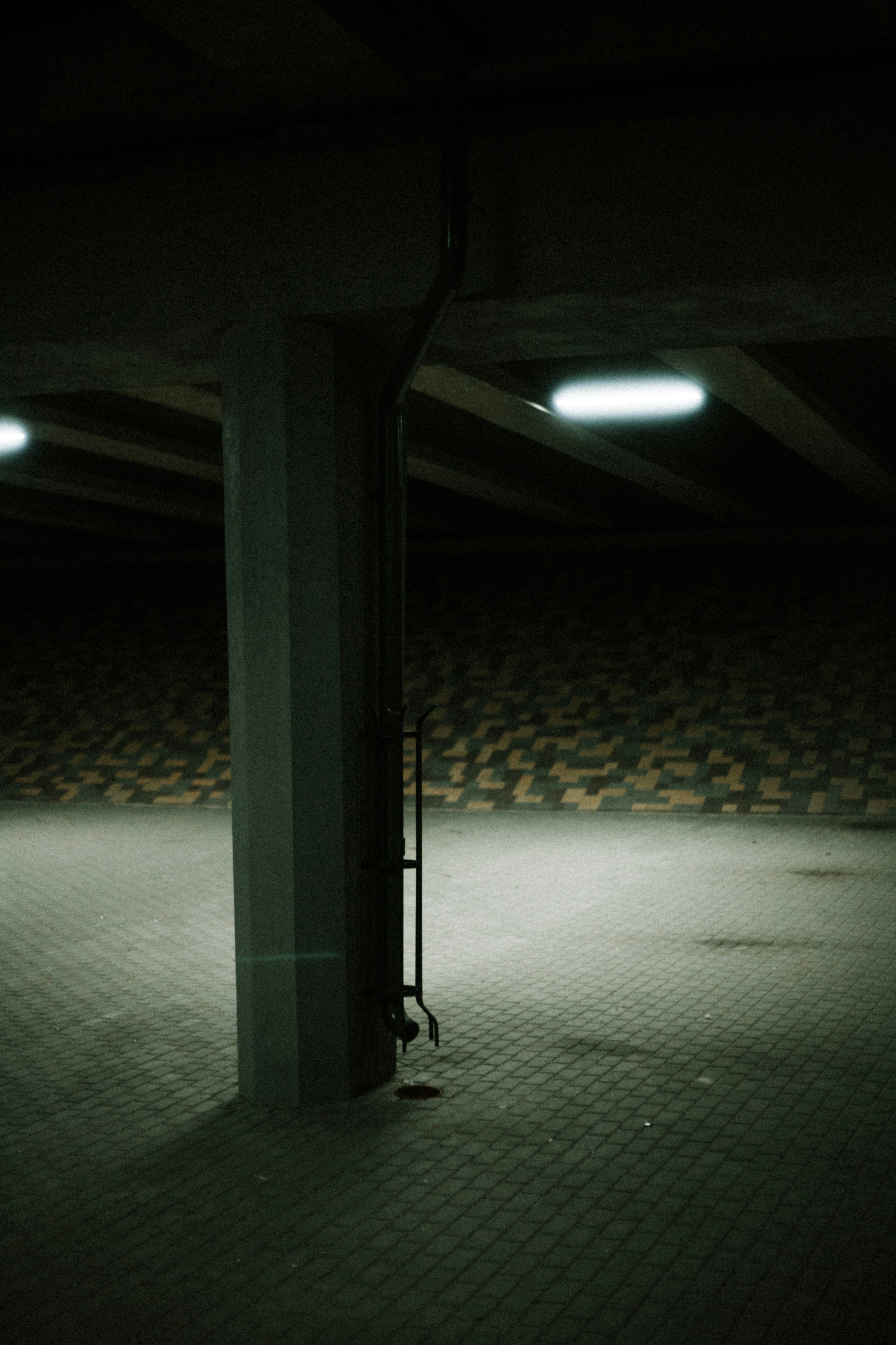 Vertical Pillar Under Fluorescent Vigil in an Empty Underground Space