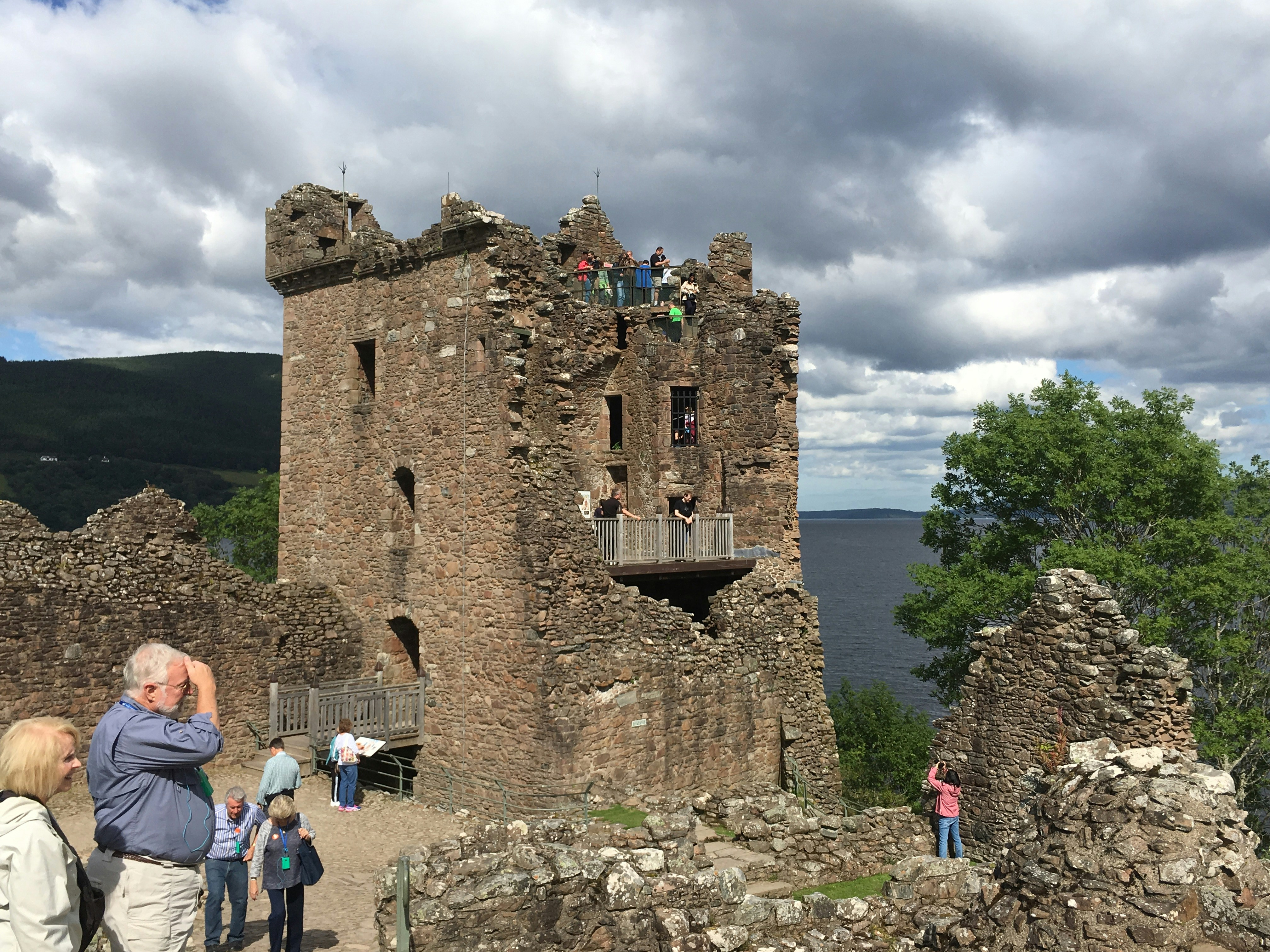 Weathered Keep by the Sea: Visitors on a Crumbling Tower