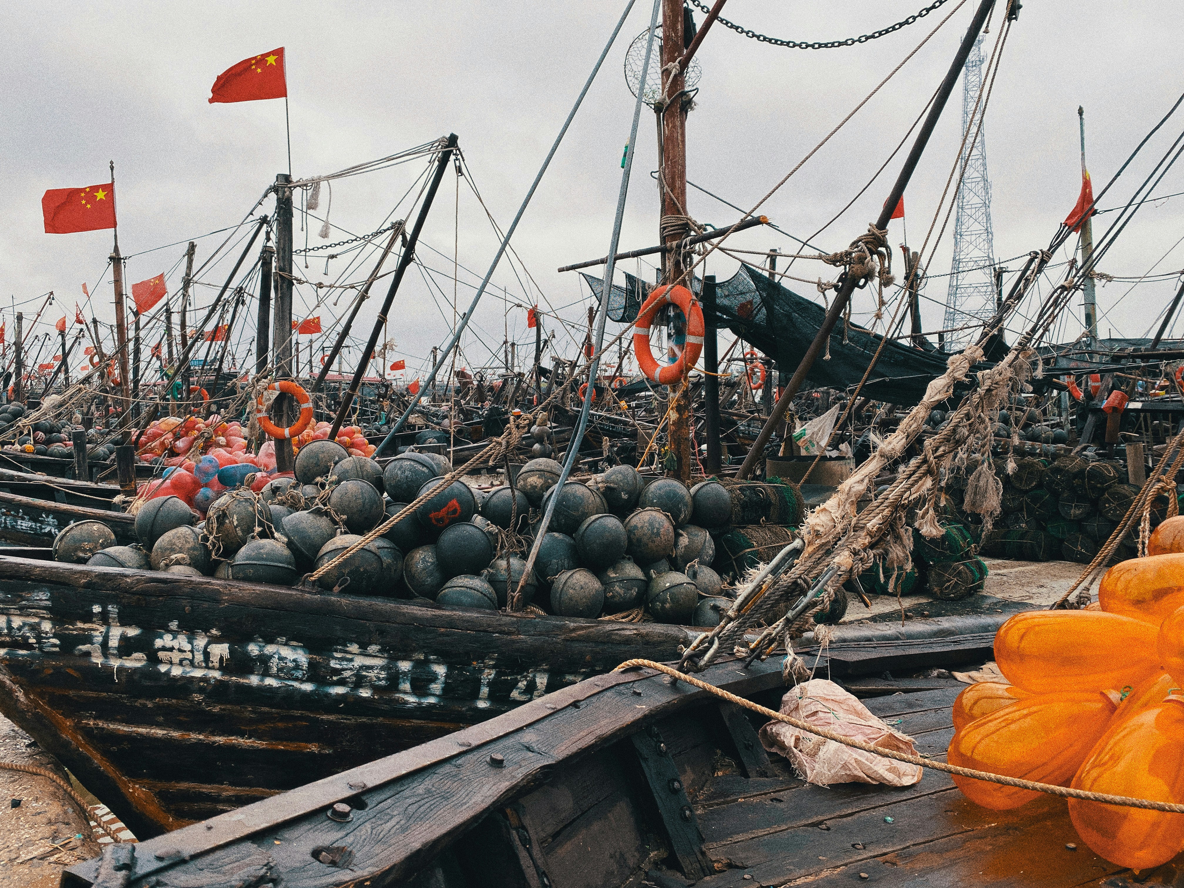 Red Flags and Ropes: A Dense Chinese Fishing Fleet at the Harbor