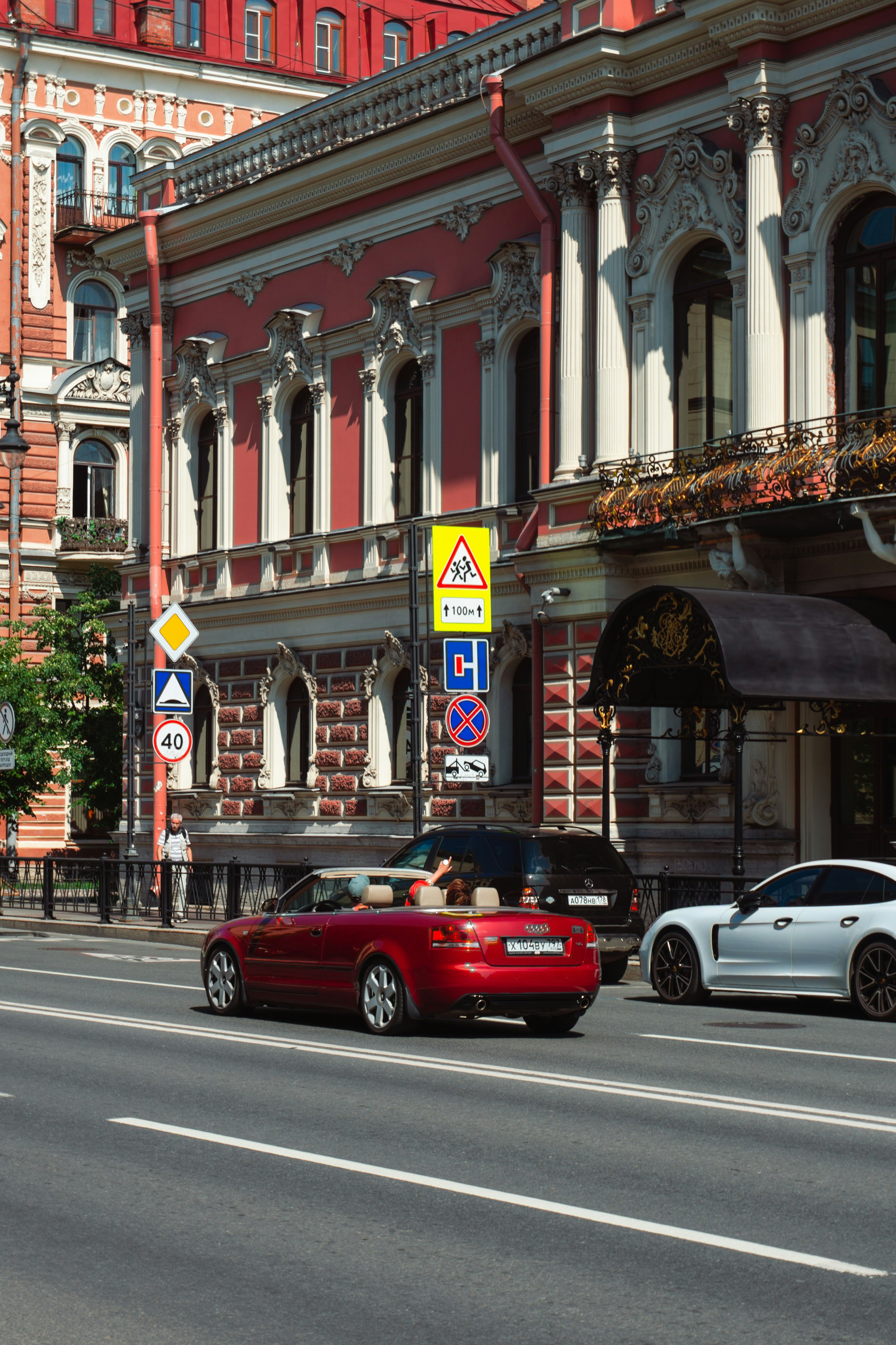 Crimson Convertible on a Sunlit Street Framed by Ornate Facades