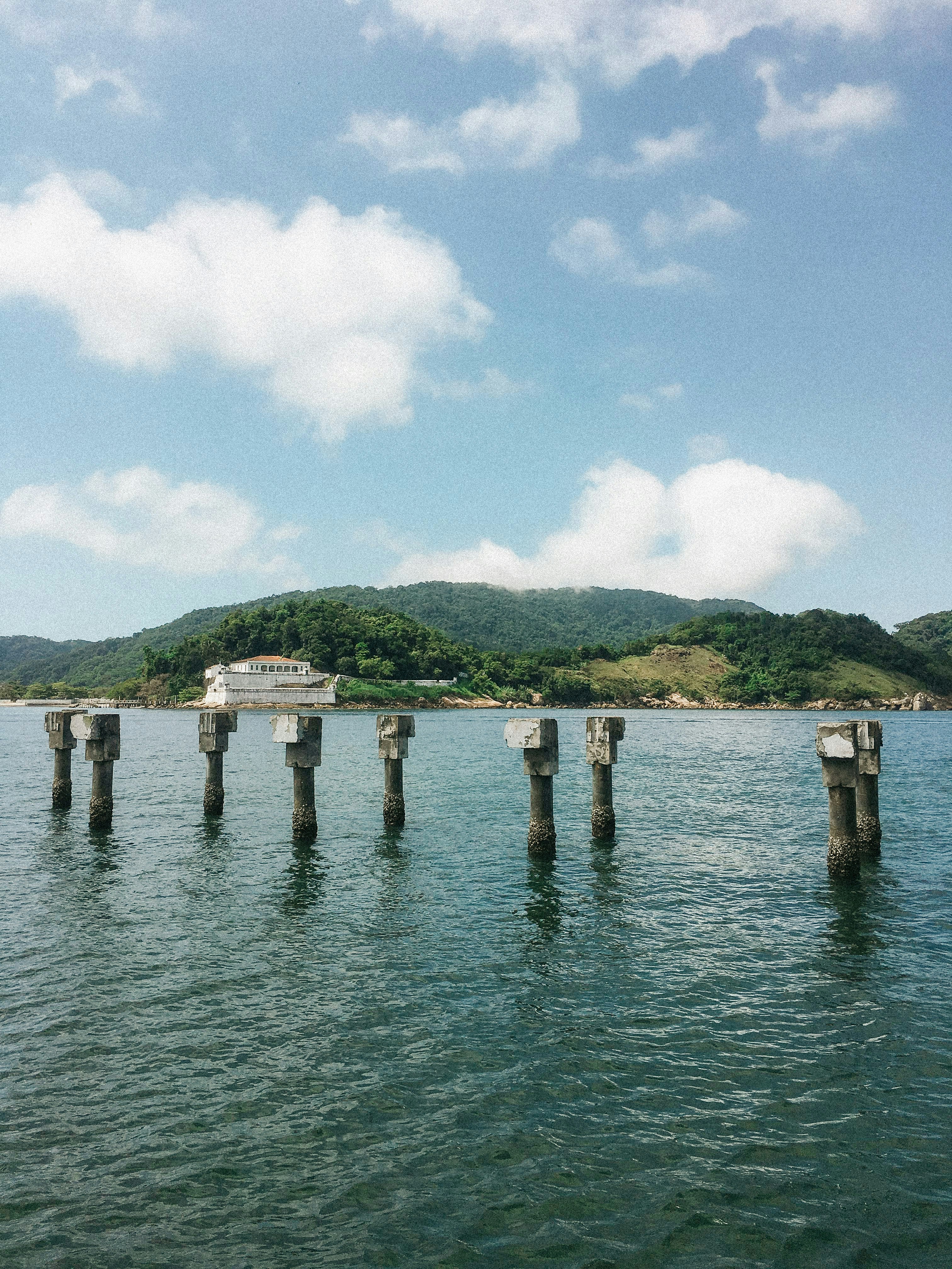 a body of water with a building on the shore