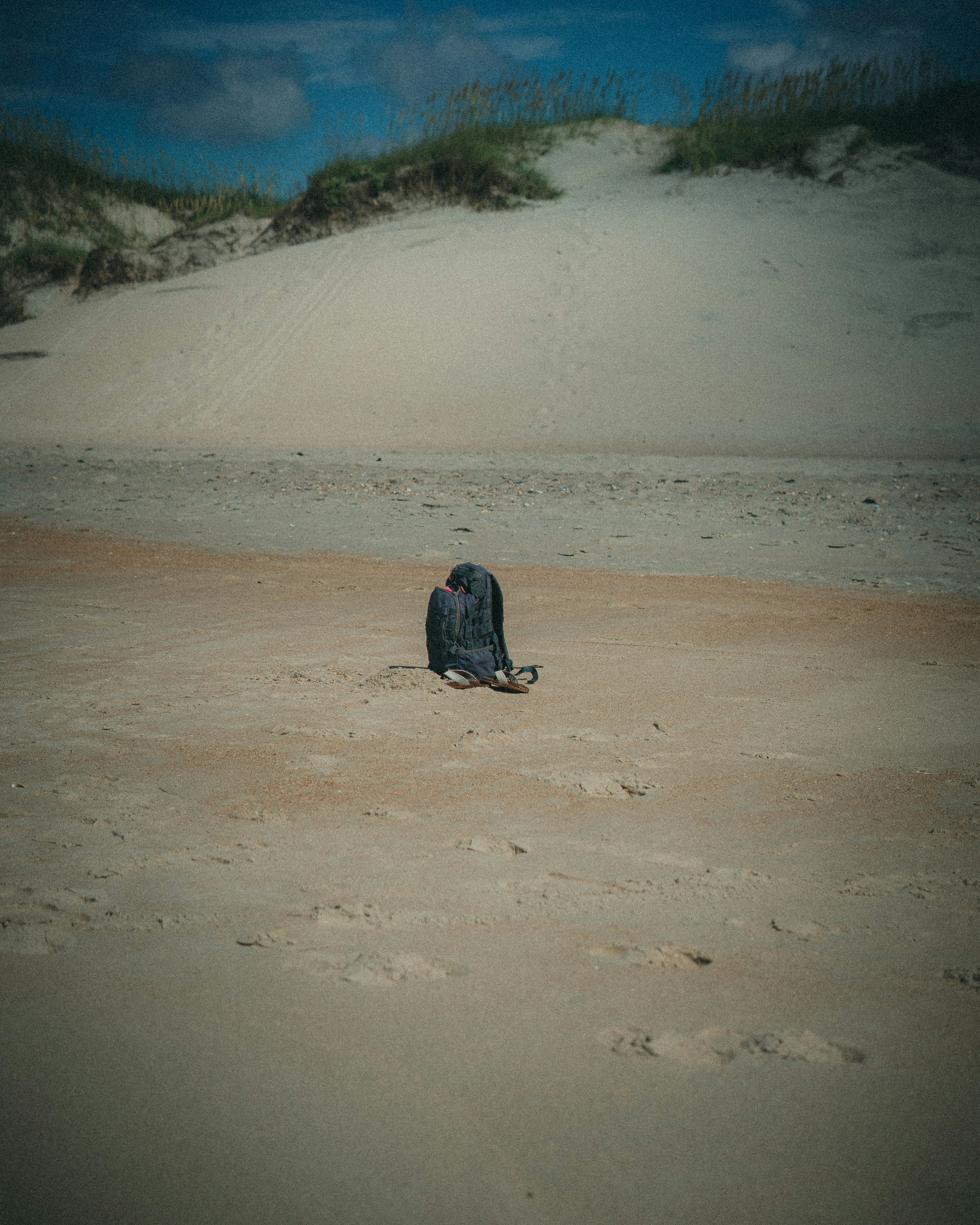 Backpack at the Quiet Edge: Solitude on a Sunlit Dune