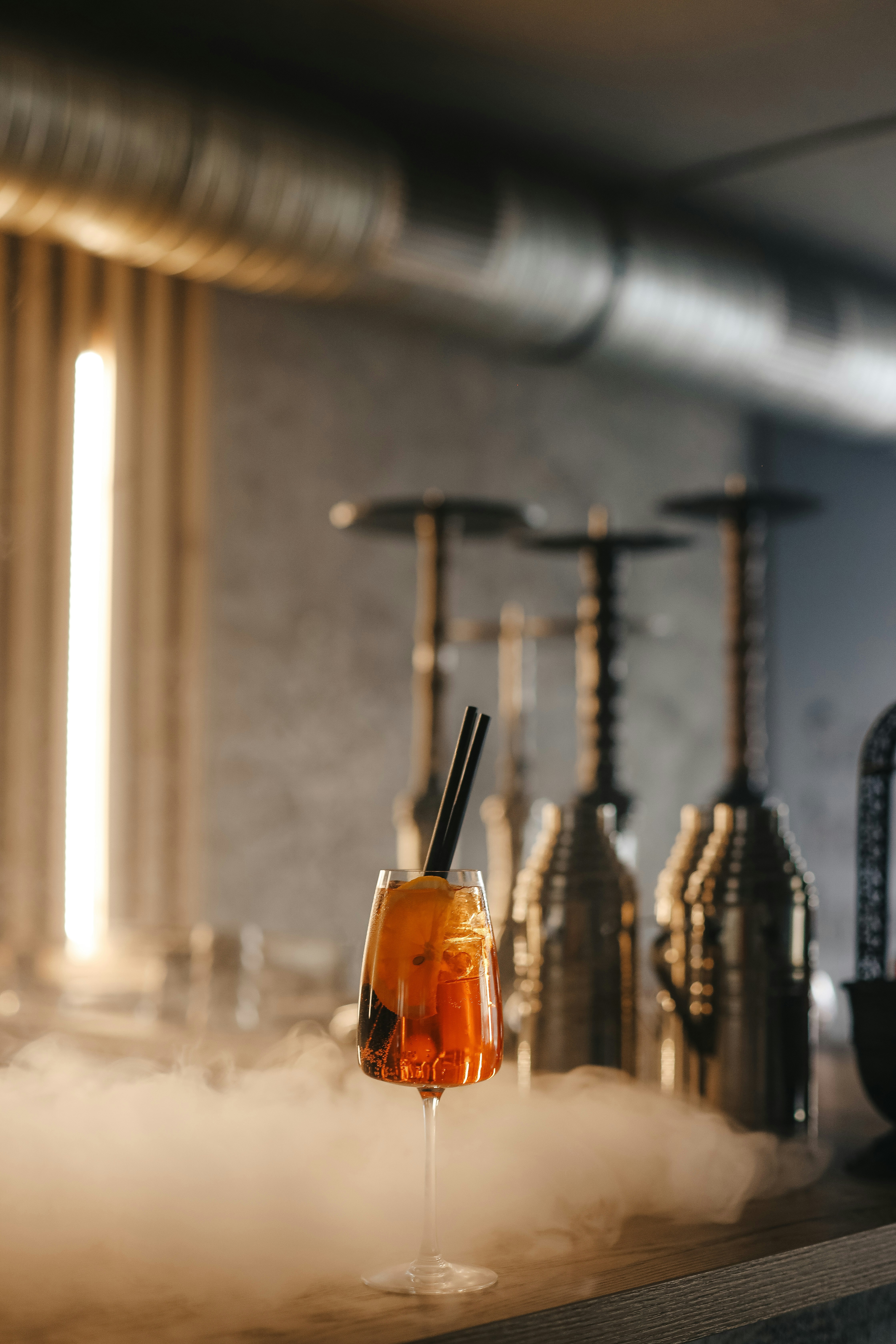 a glass of liquid with a straw