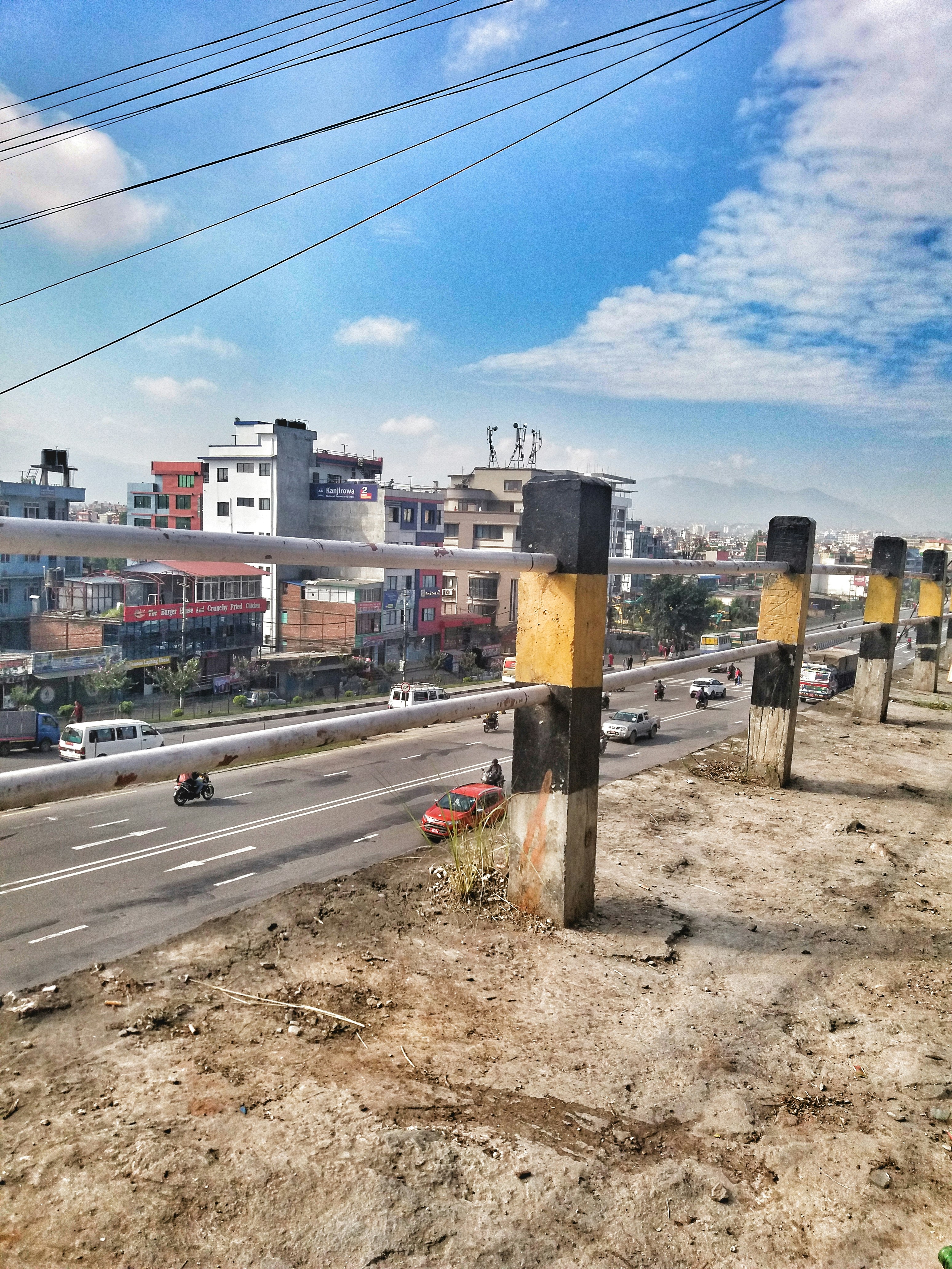 a road with cars and buildings on the side