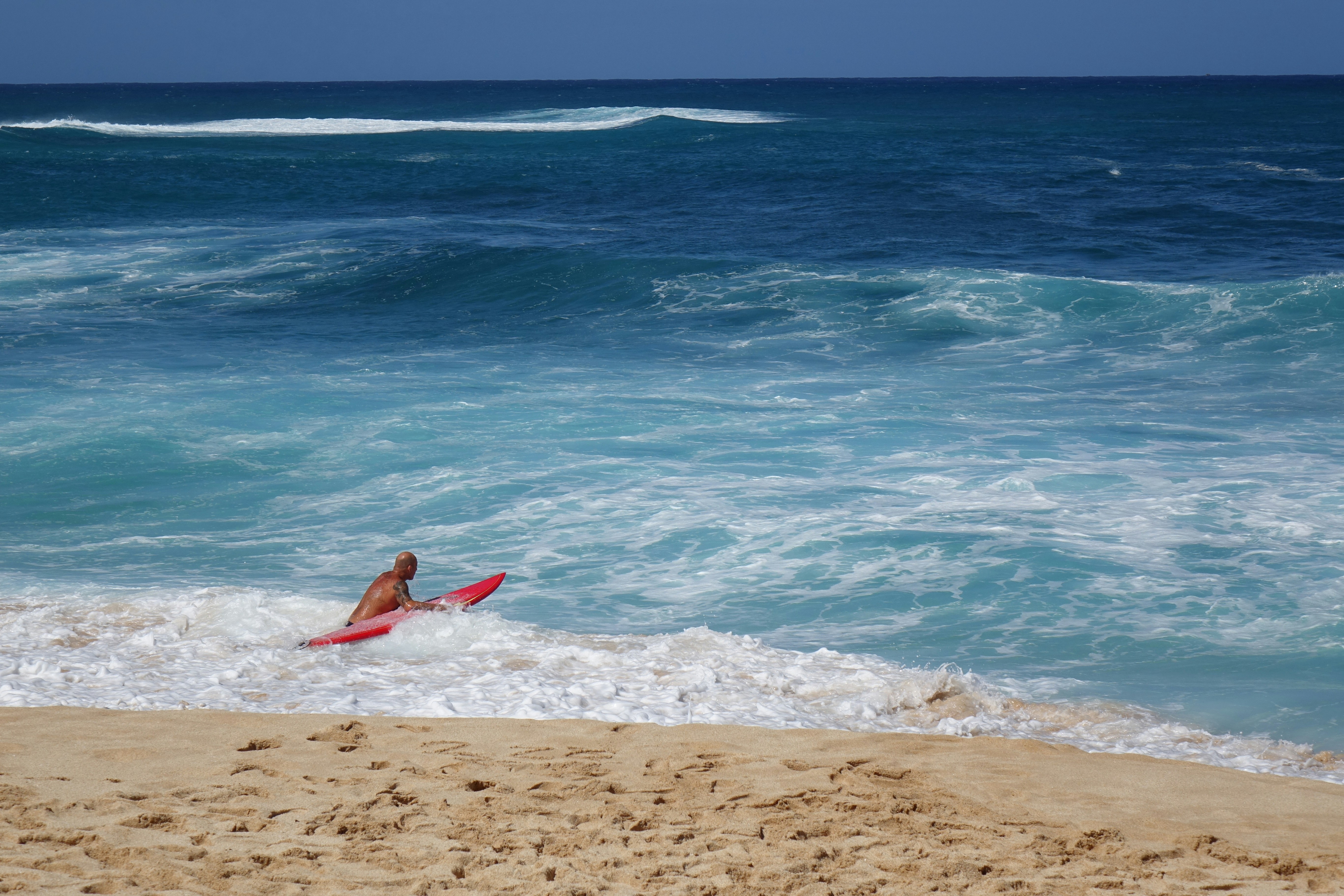 Surf Rider at the Edge of Light-blue Waves