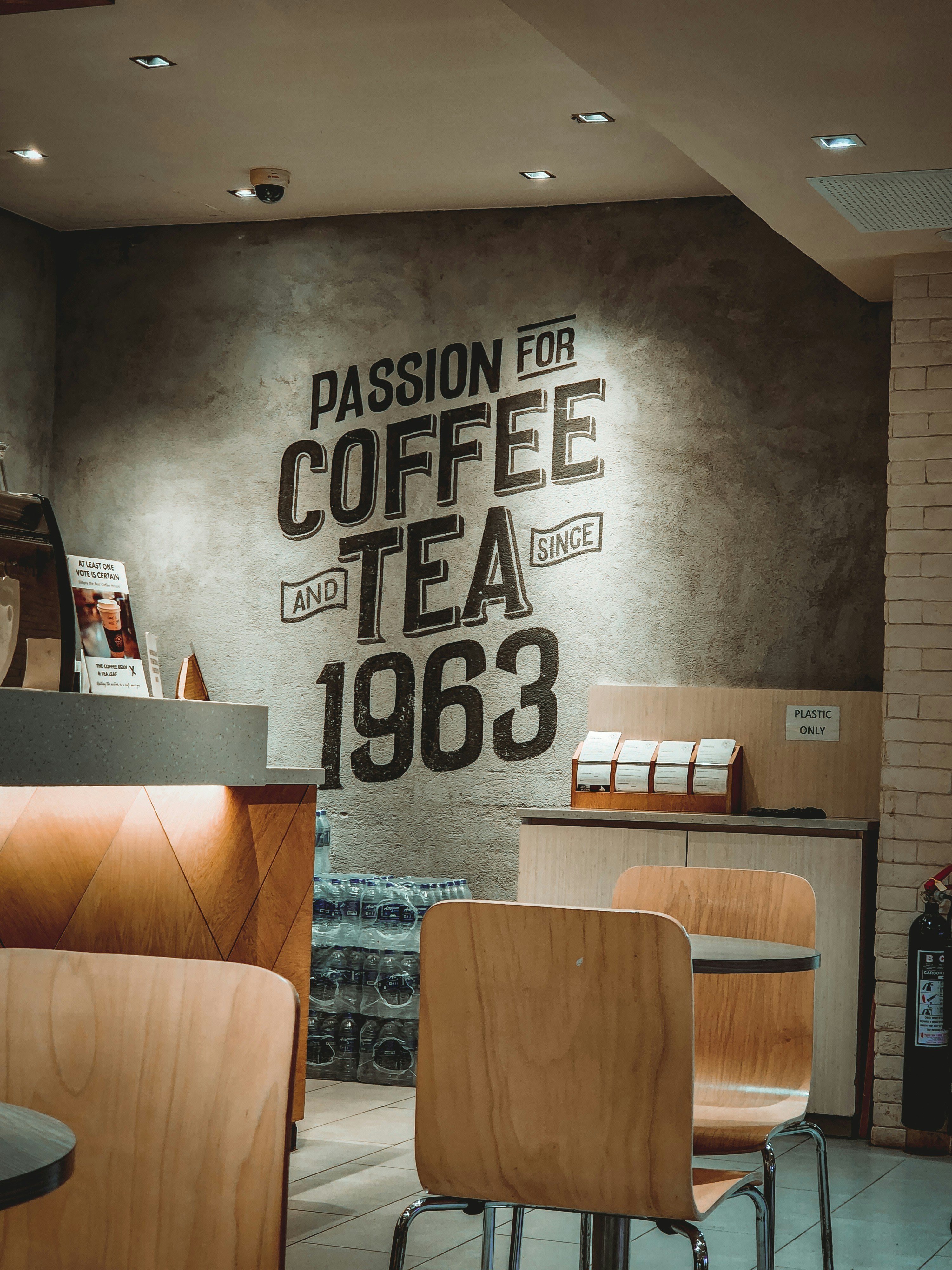 1963 Echoes: A Café Interior Framed by Bold Coffee and Tea Typography