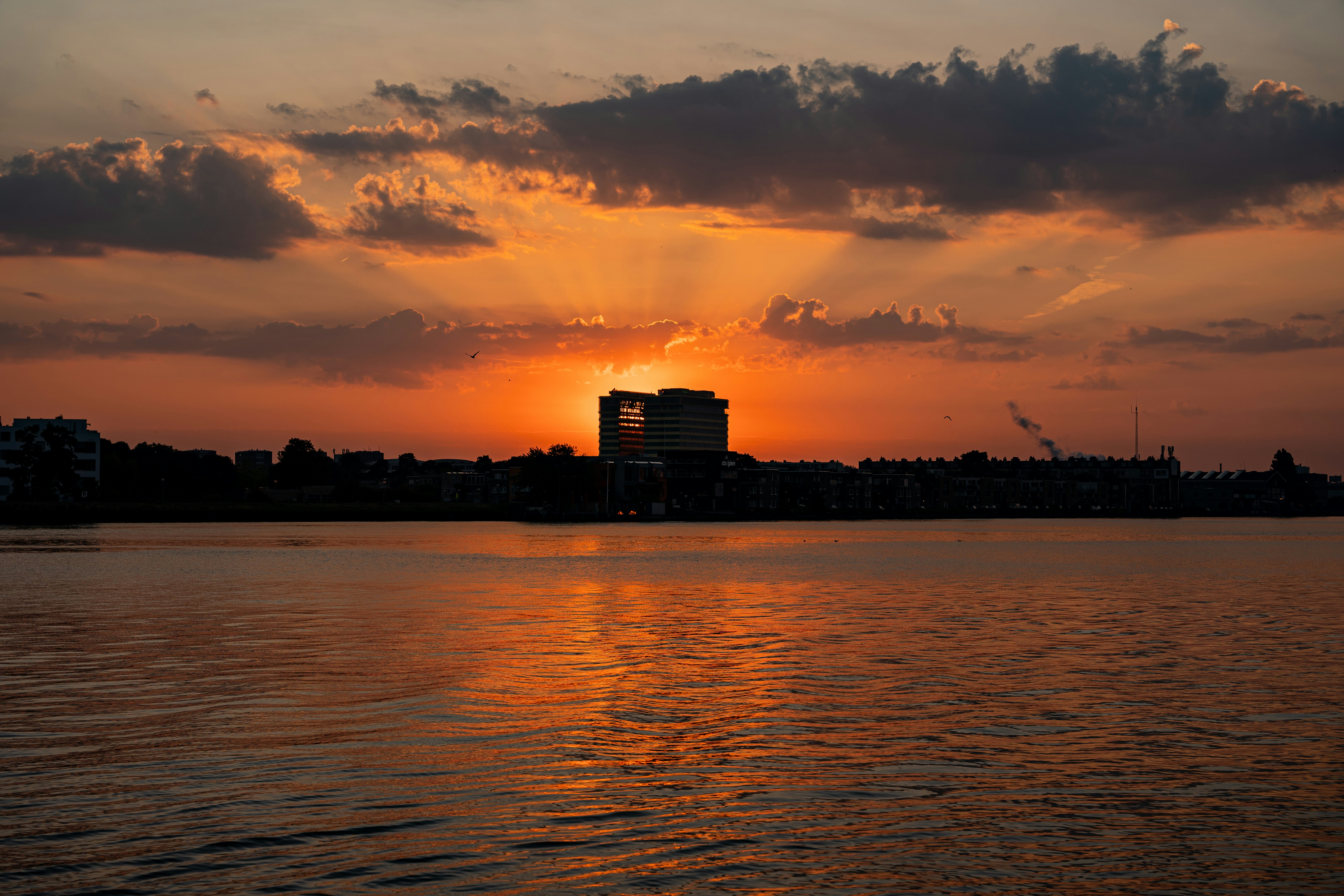Ember Horizon Over a Silent Riverfront Skyline