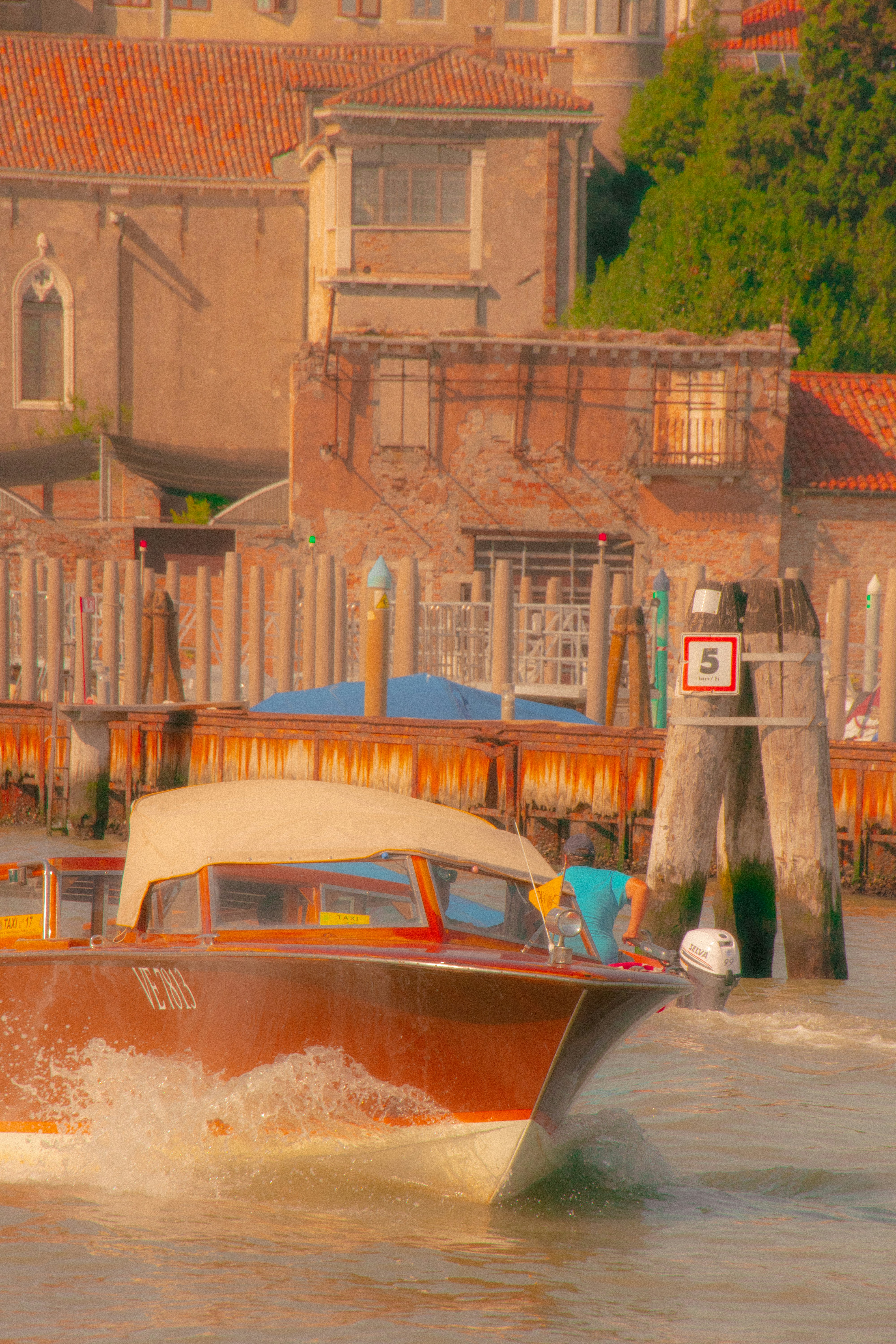 Amber Wake Along a Venetian Waterfront