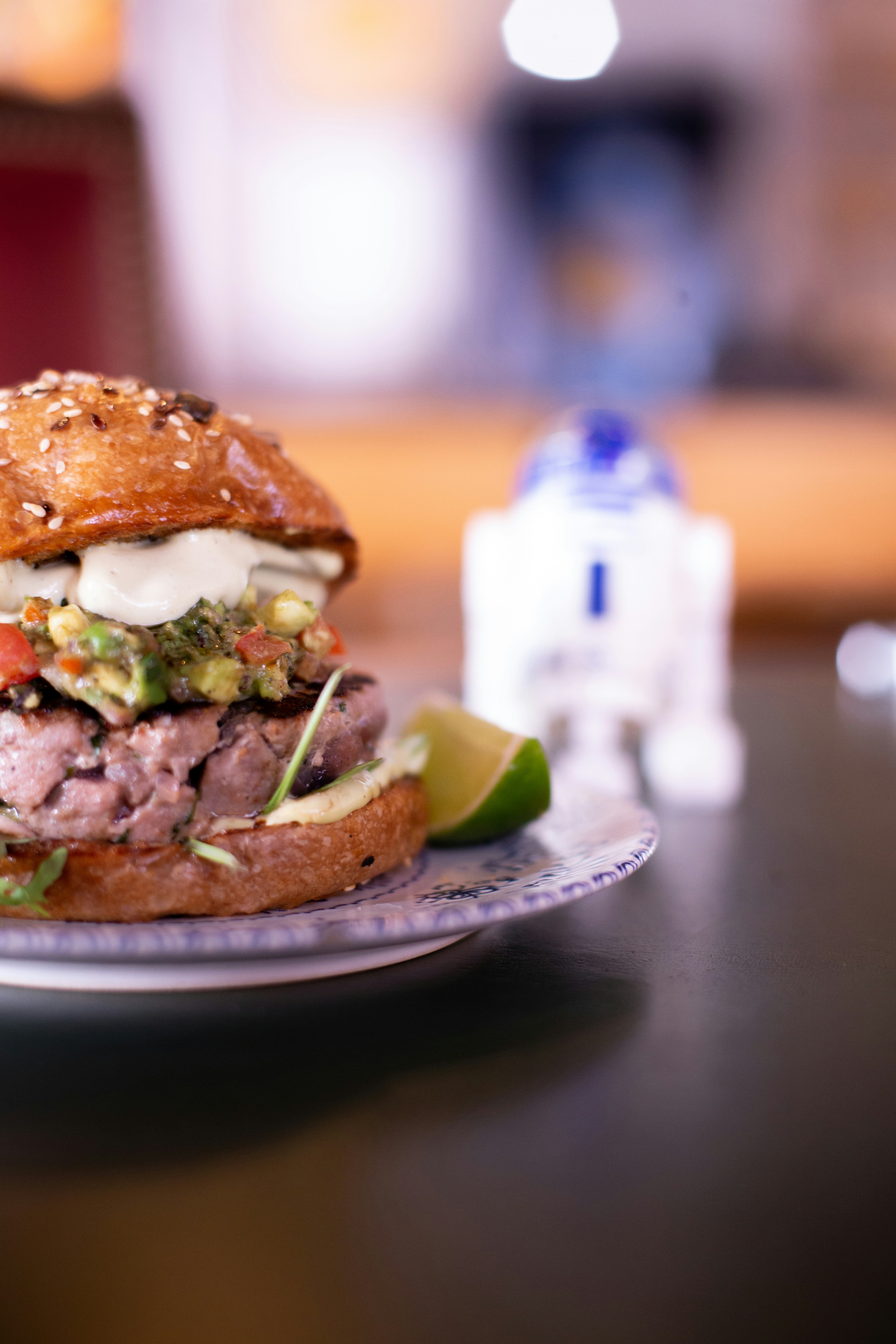 Juicy Smash: A cheeseburger in focus amidst a blurred kitchen scene
