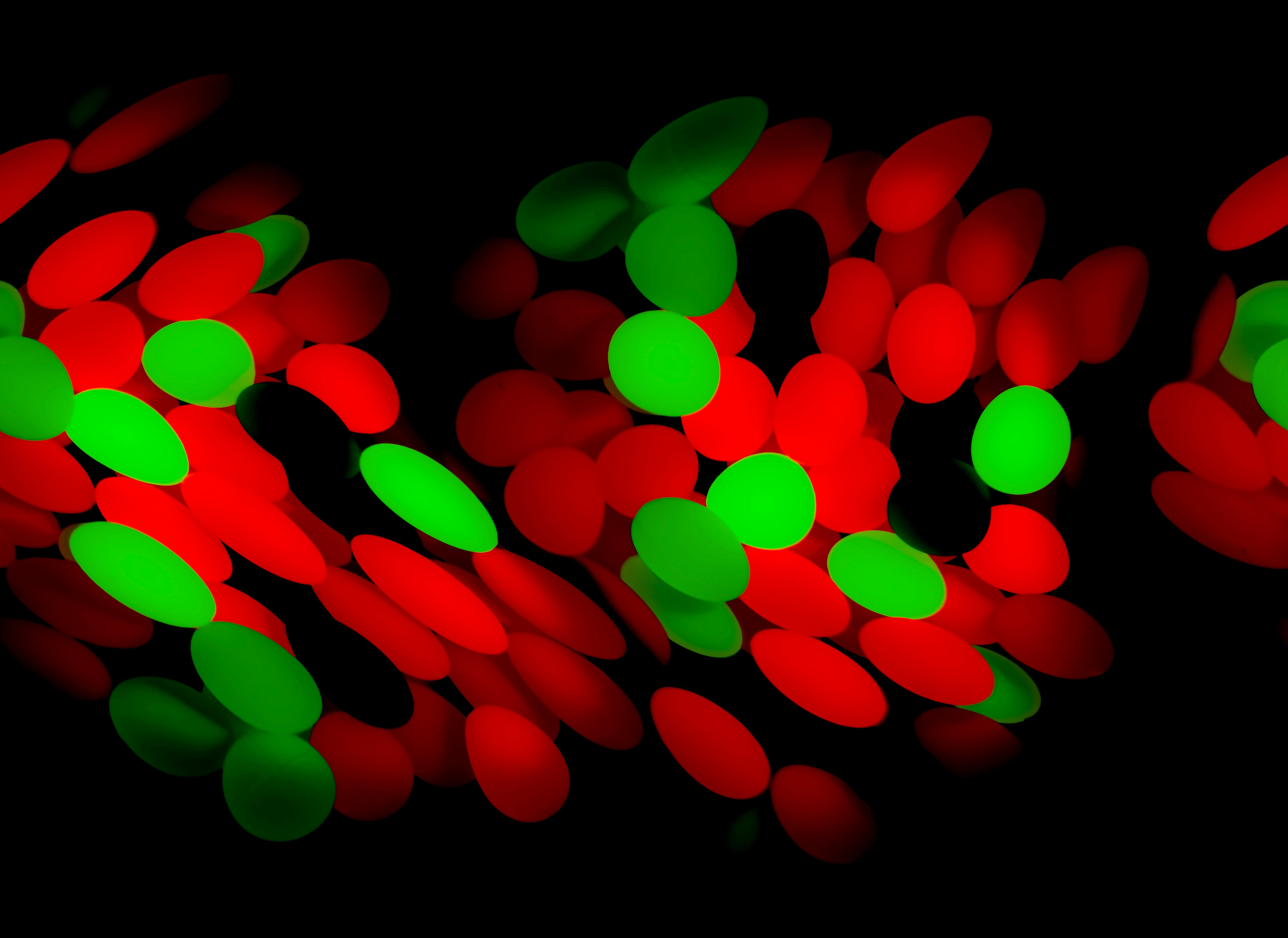 Emerald and Crimson Bokeh: Red and Green Orbs on Velvet Black