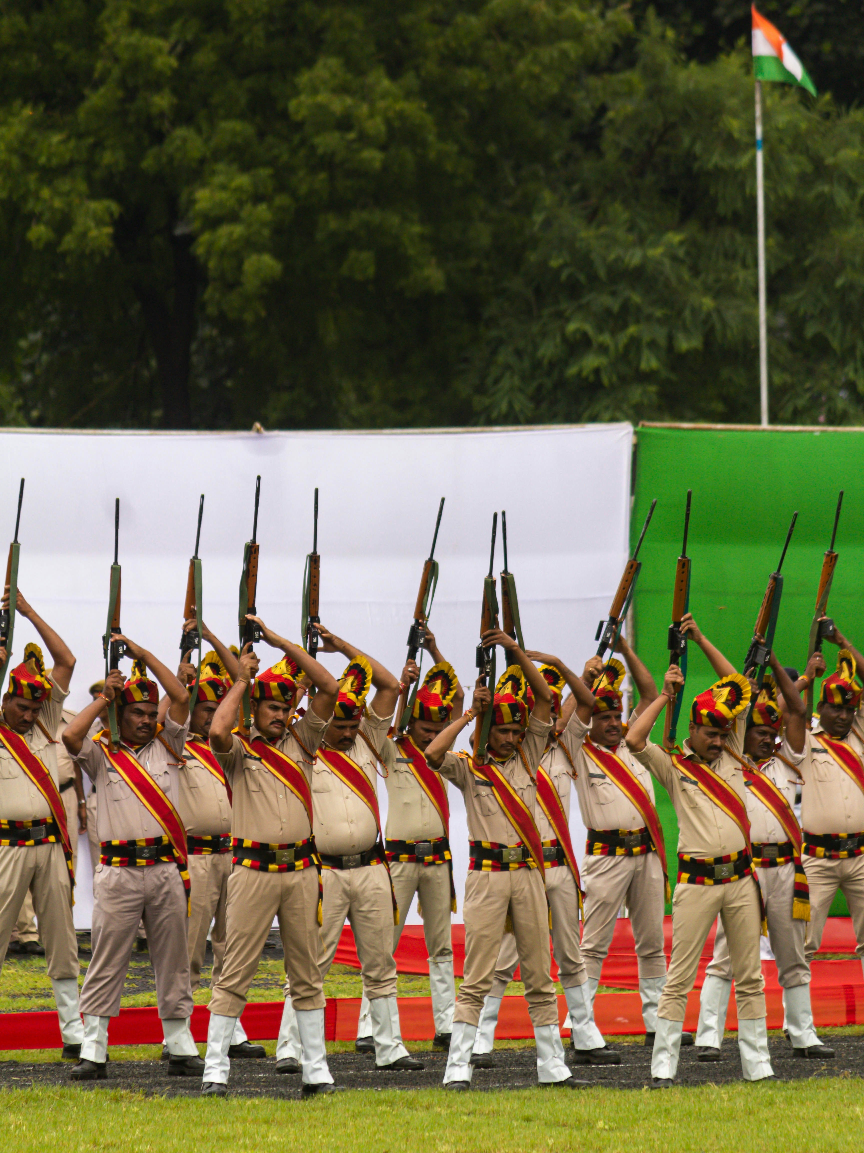 A group of people in red and white uniforms marching photo – Free ...