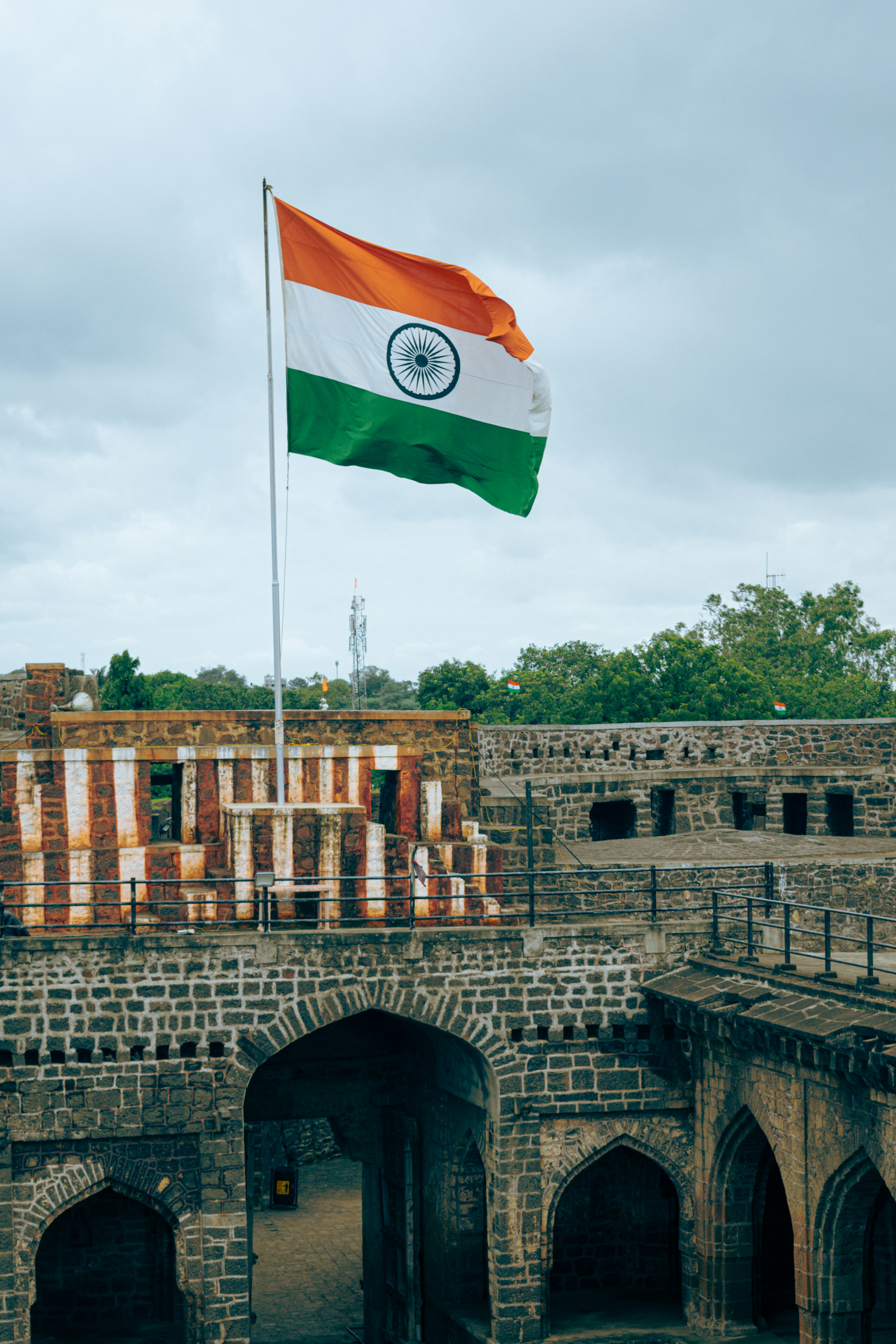 Flag Over Stone Arch: India’s Tricolor Floats Above Fort Windows