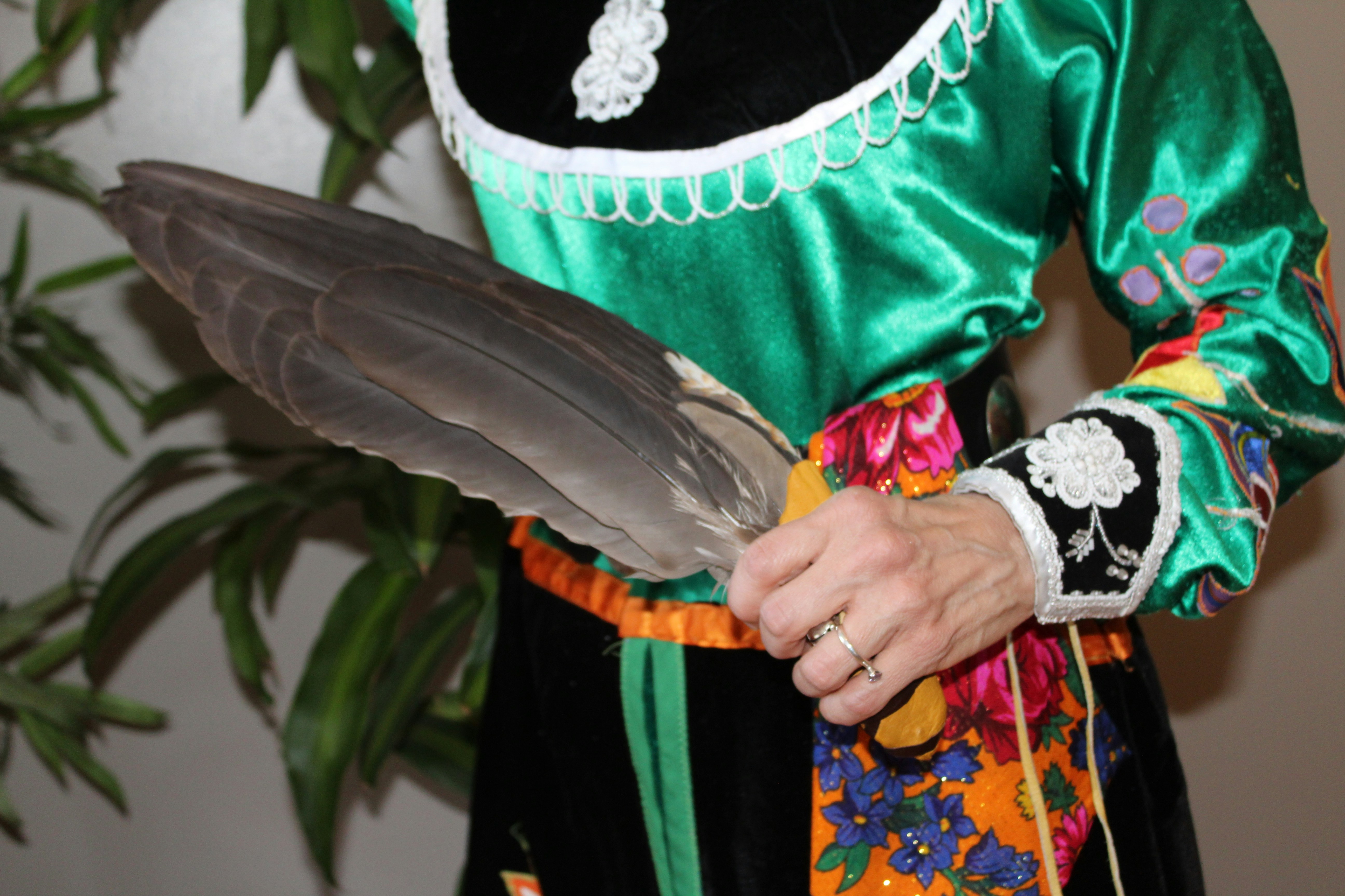 Feathered Gesture: Holding a Wing in Traditional Attire