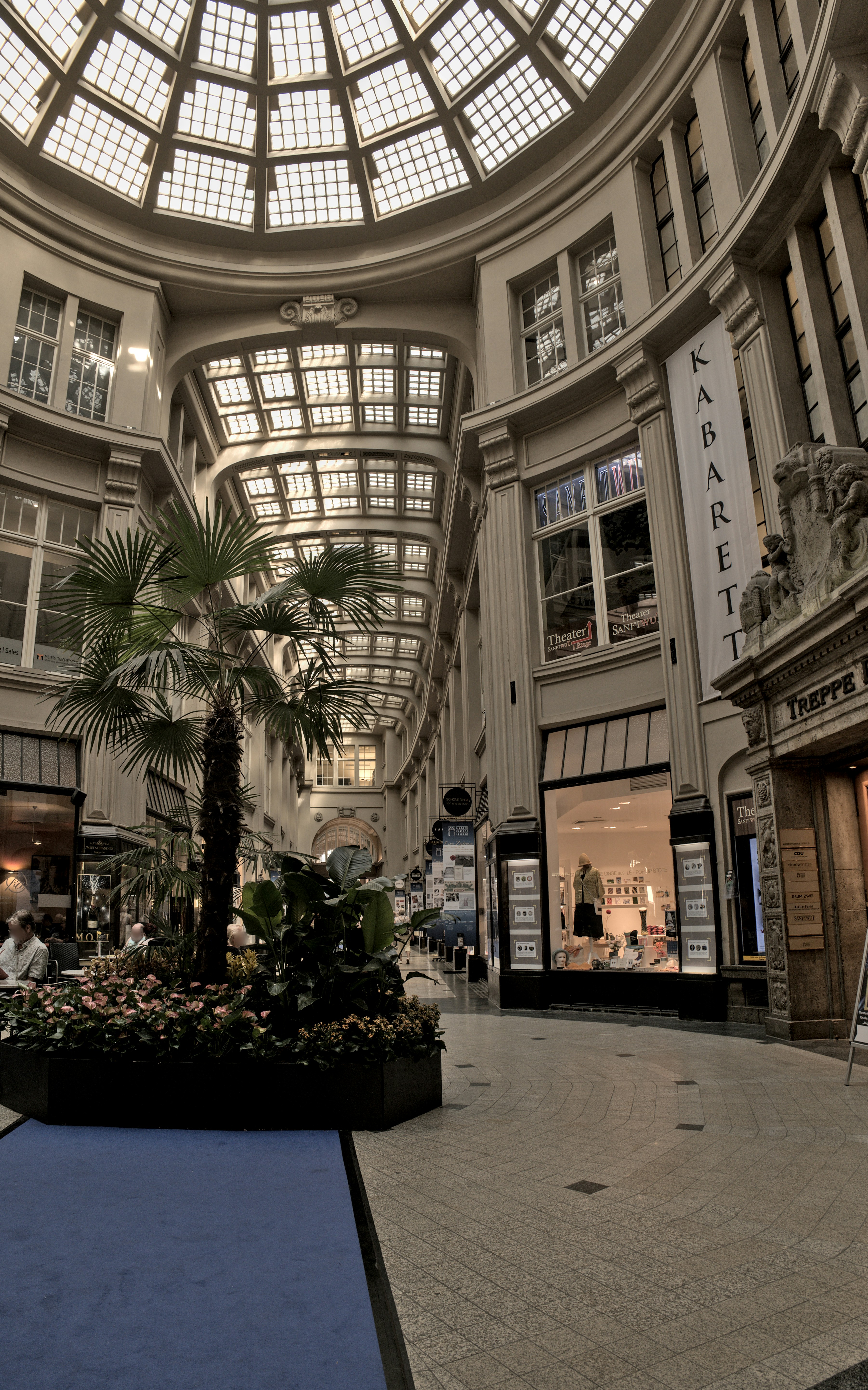 Palm-Lined Atrium Under a Glass Dome: An Arcaded Corridor in Warm Sepia