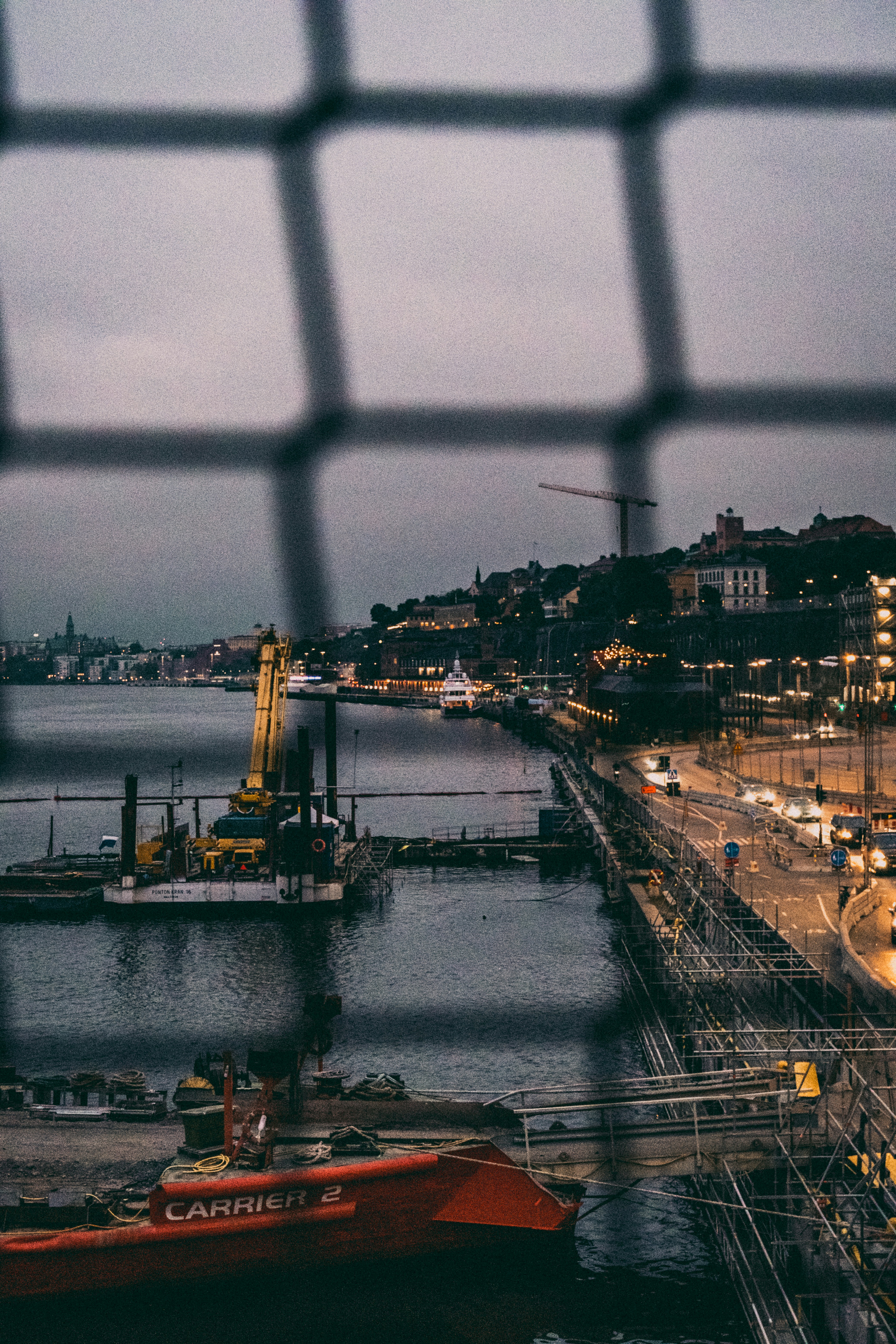 Crane at Dusk Over a Lantern-Lit Harbor