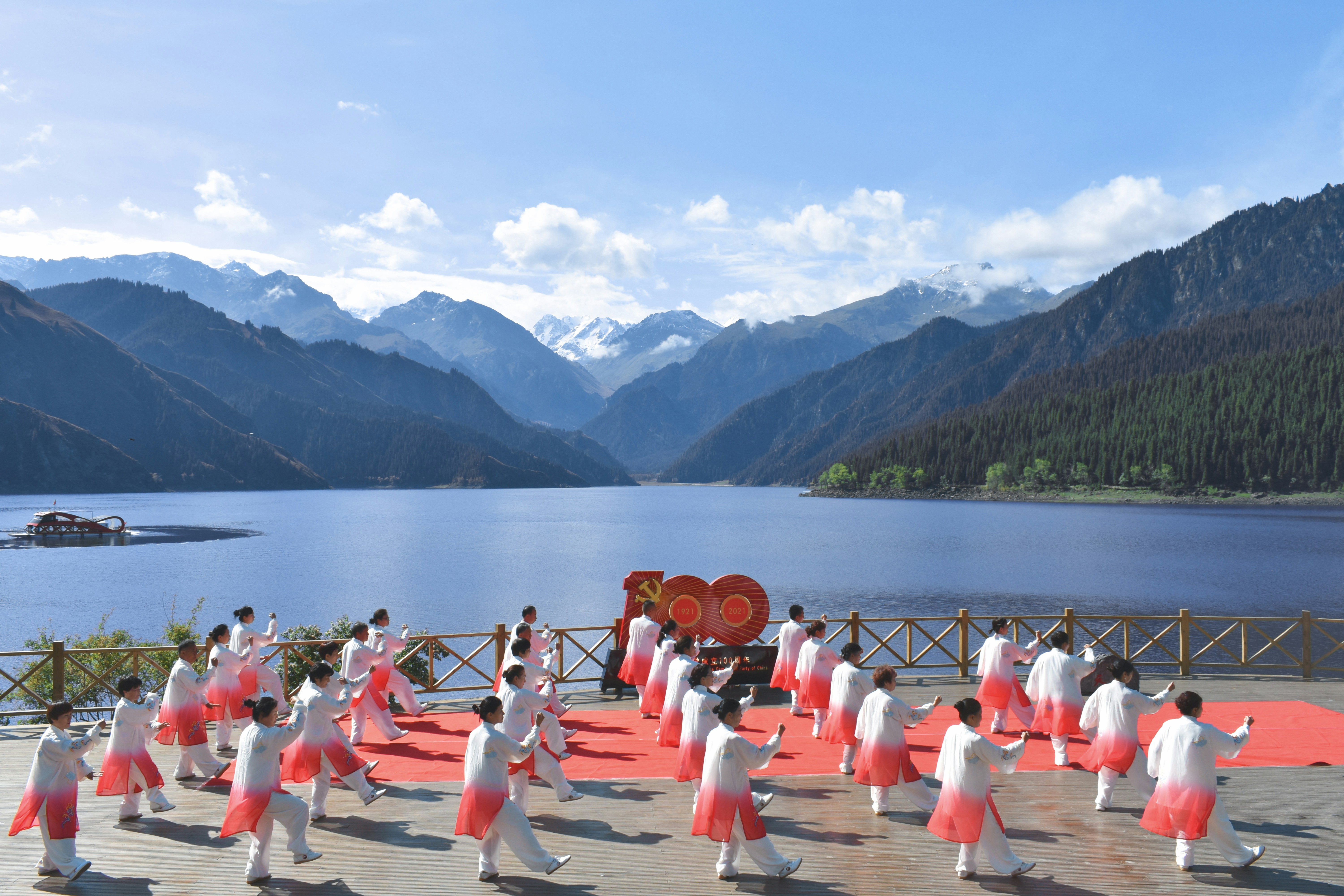 A group of people in white karate uniforms on a dock by a lake photo ...