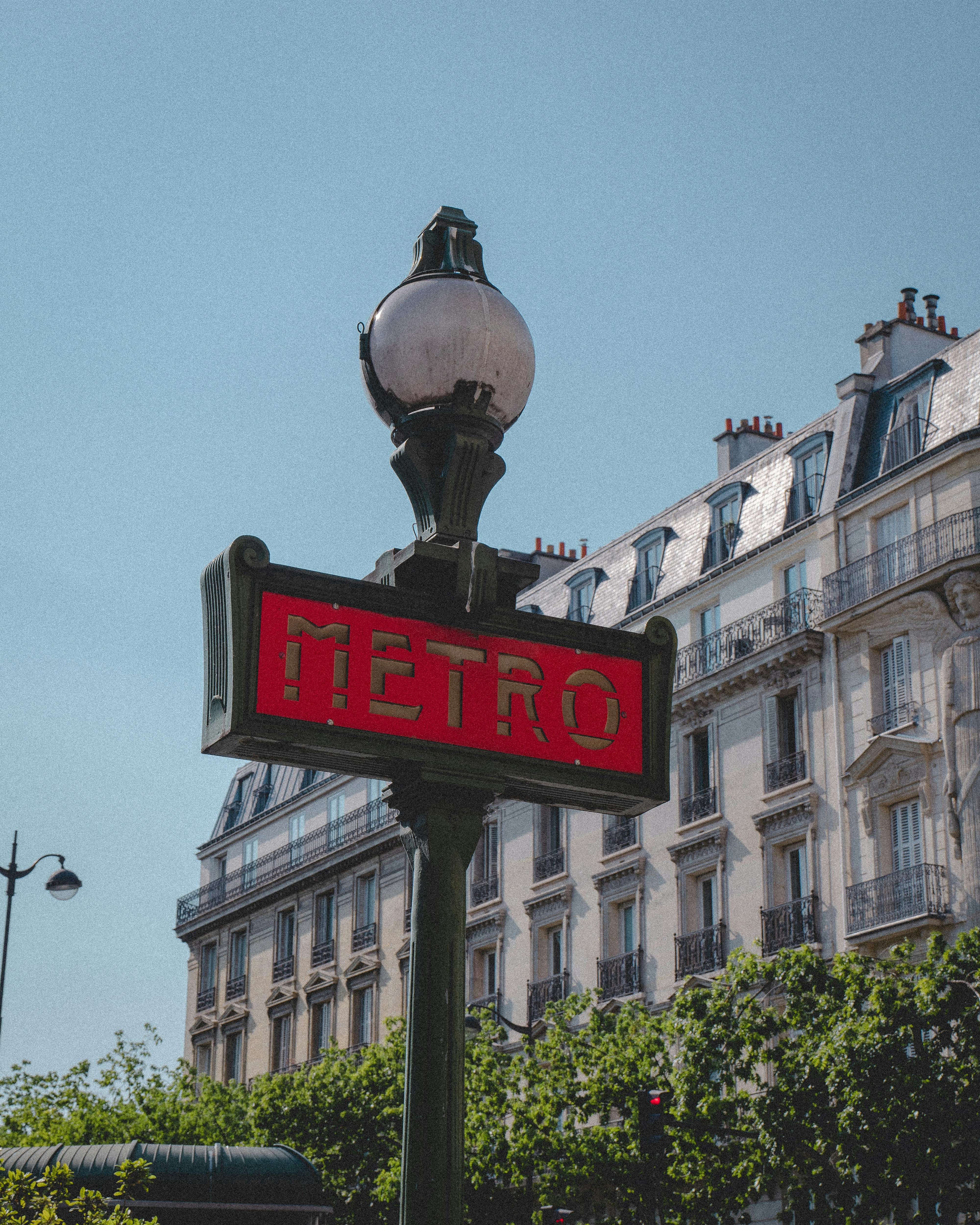 Red METRO Sign as a Beacon Against Parisian Haussmannian Facades