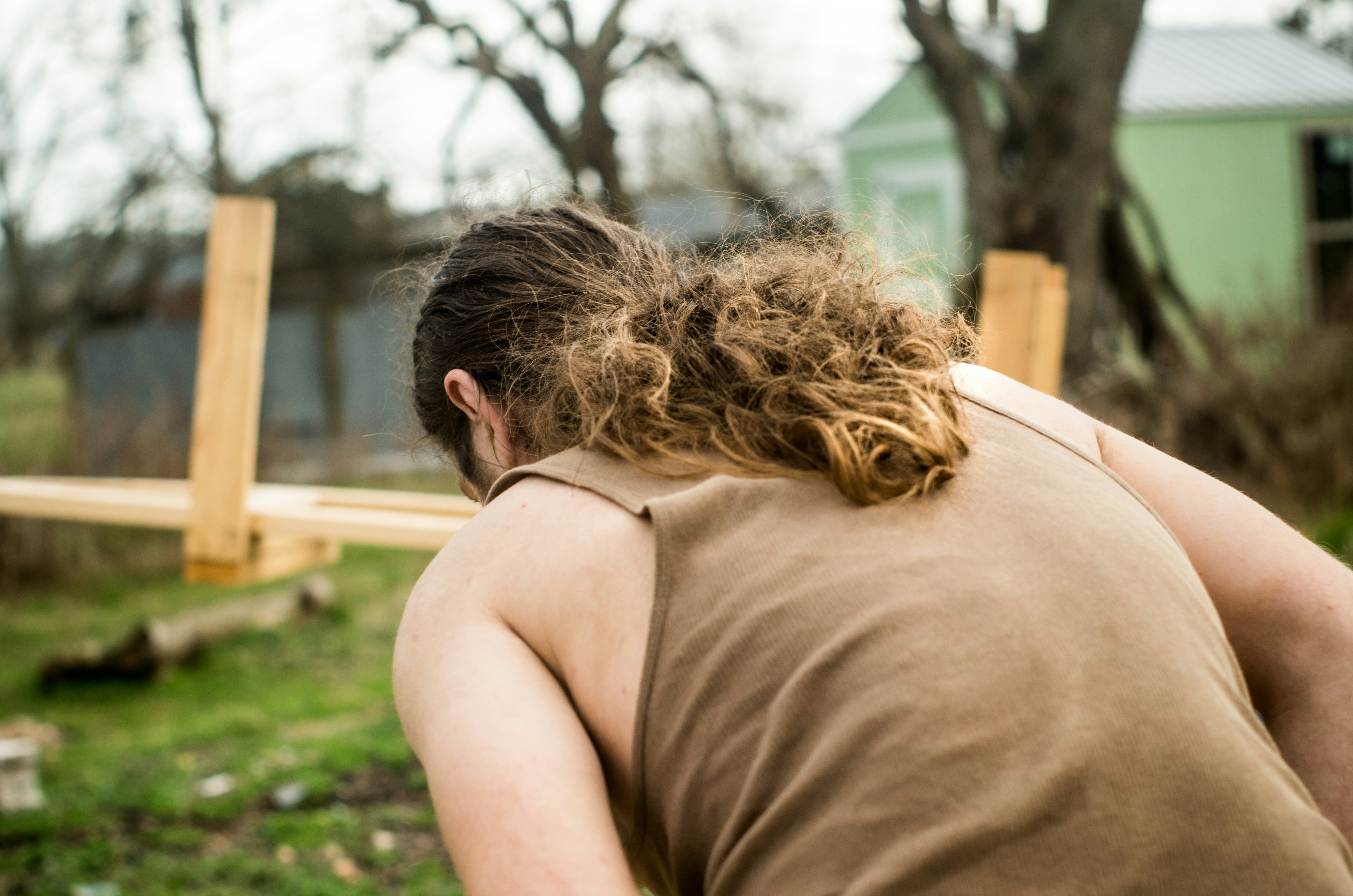 working on construction project on a farm // CC0 Public Domain Image | a man with his hair blowing in the wind
