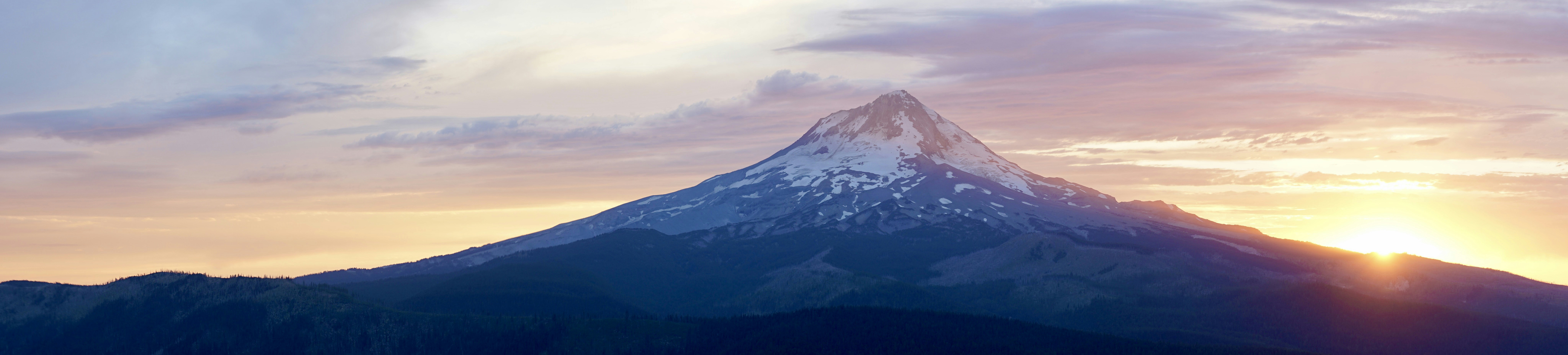 Dawn Crown: Snowy Peak Over Horizon